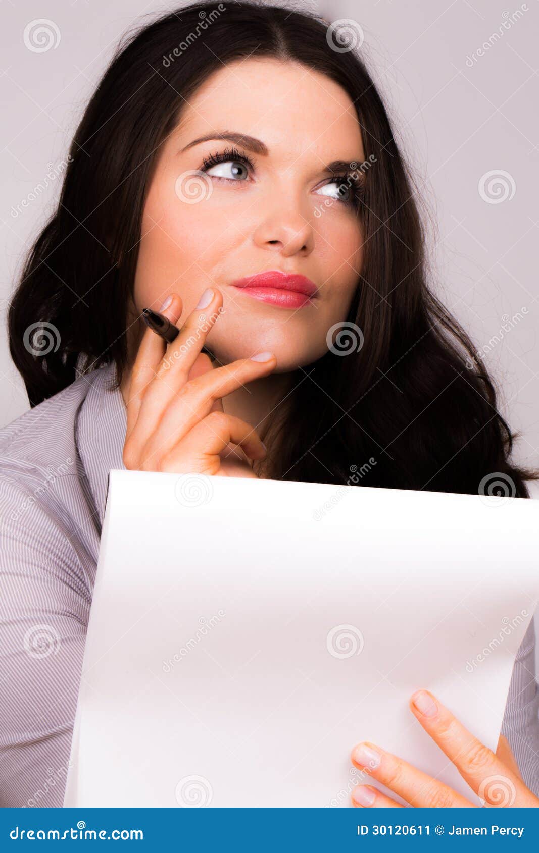 Beautiful Young Female Thinking with a Pen and Paper Stock Image ...