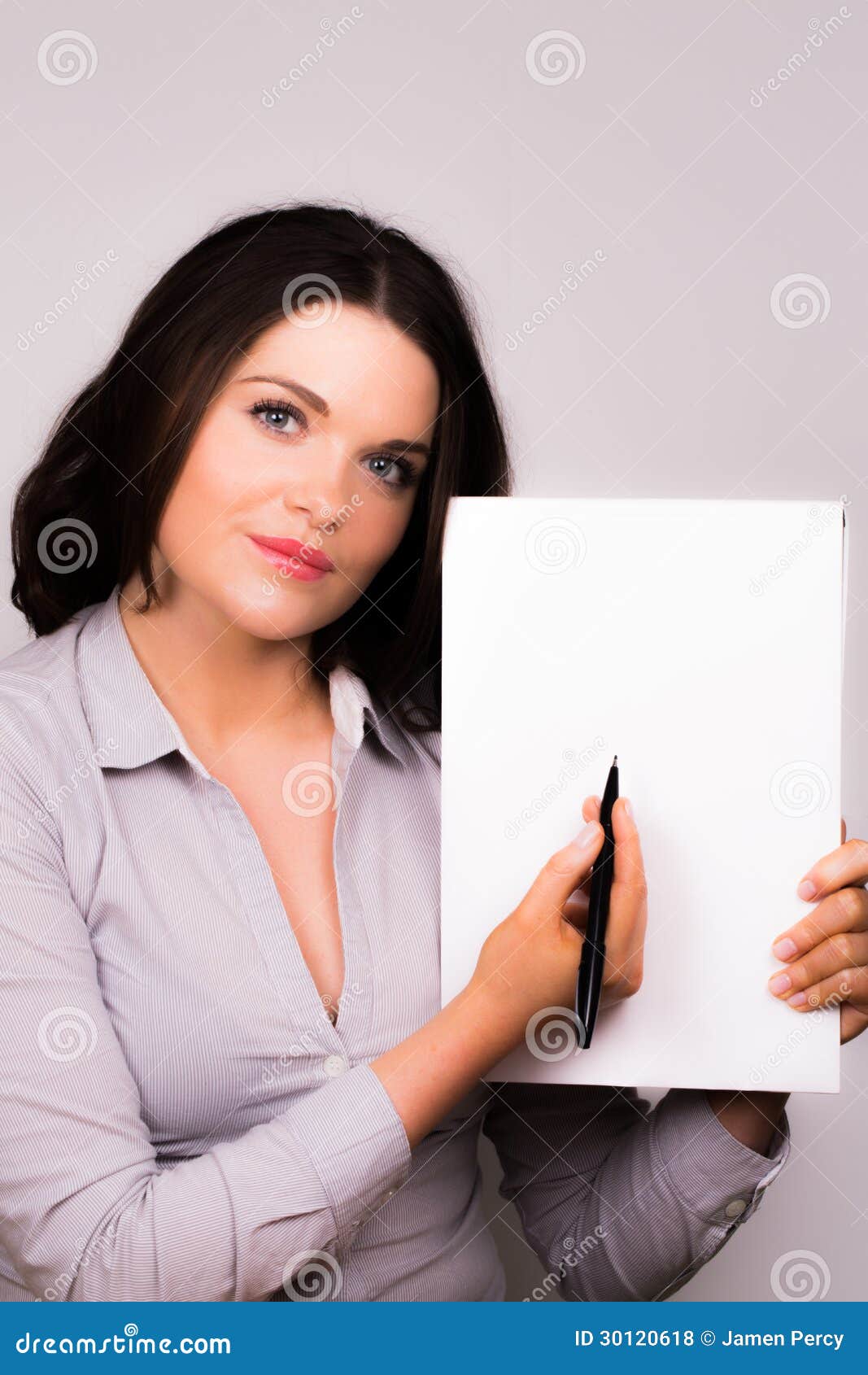 Beautiful Young Female Presenting with a Pen and Paper Stock Photo ...