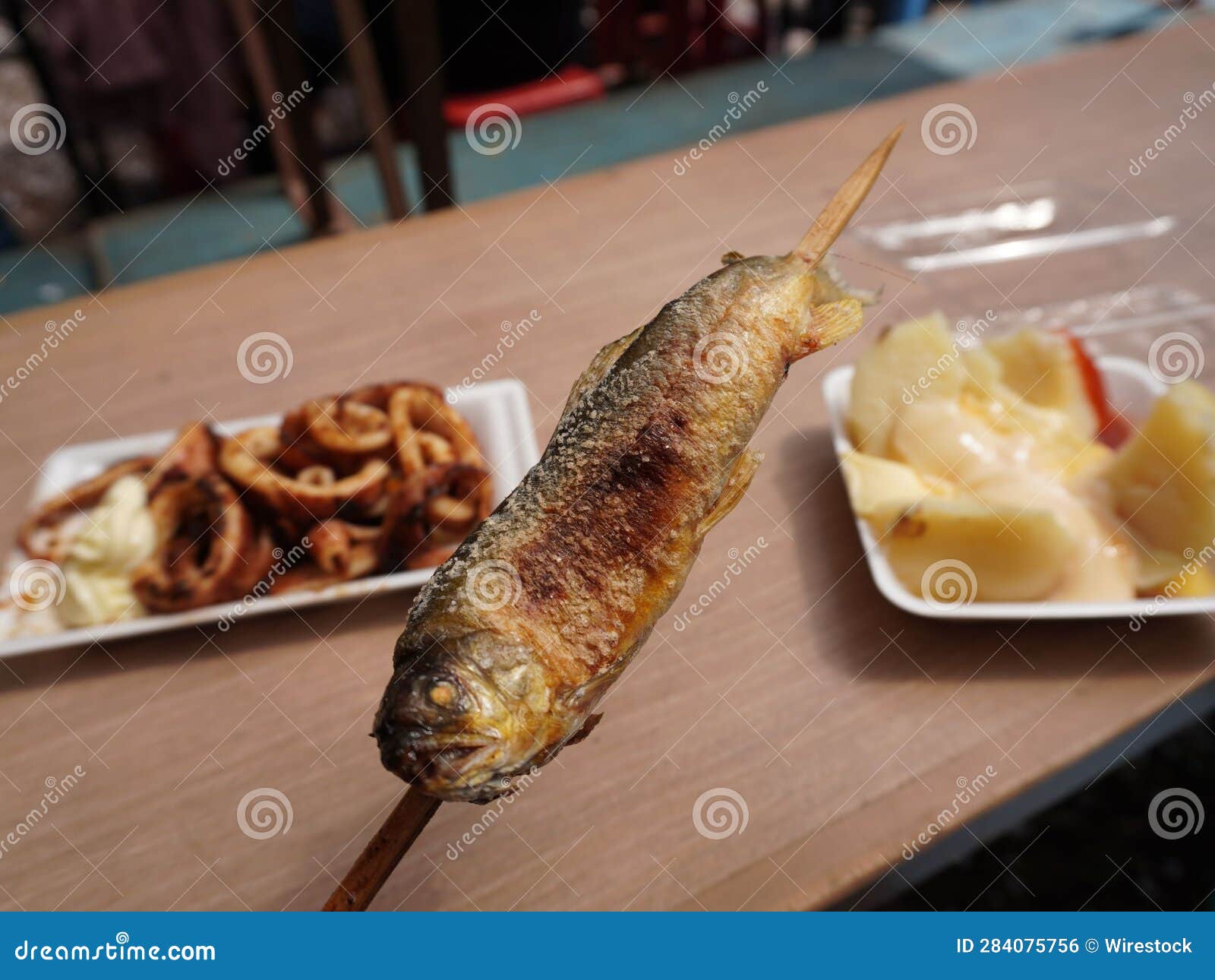 High-resolution Image of a Freshly-cooked Fish, Skewered on a Wooden ...
