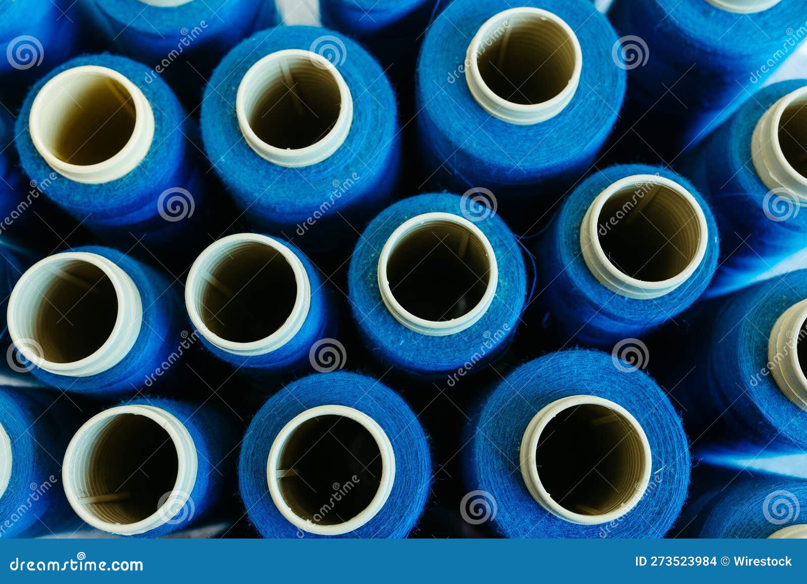 A Closeup Shot of Blue Spools of Thread Stock Photo - Image of spooling ...
