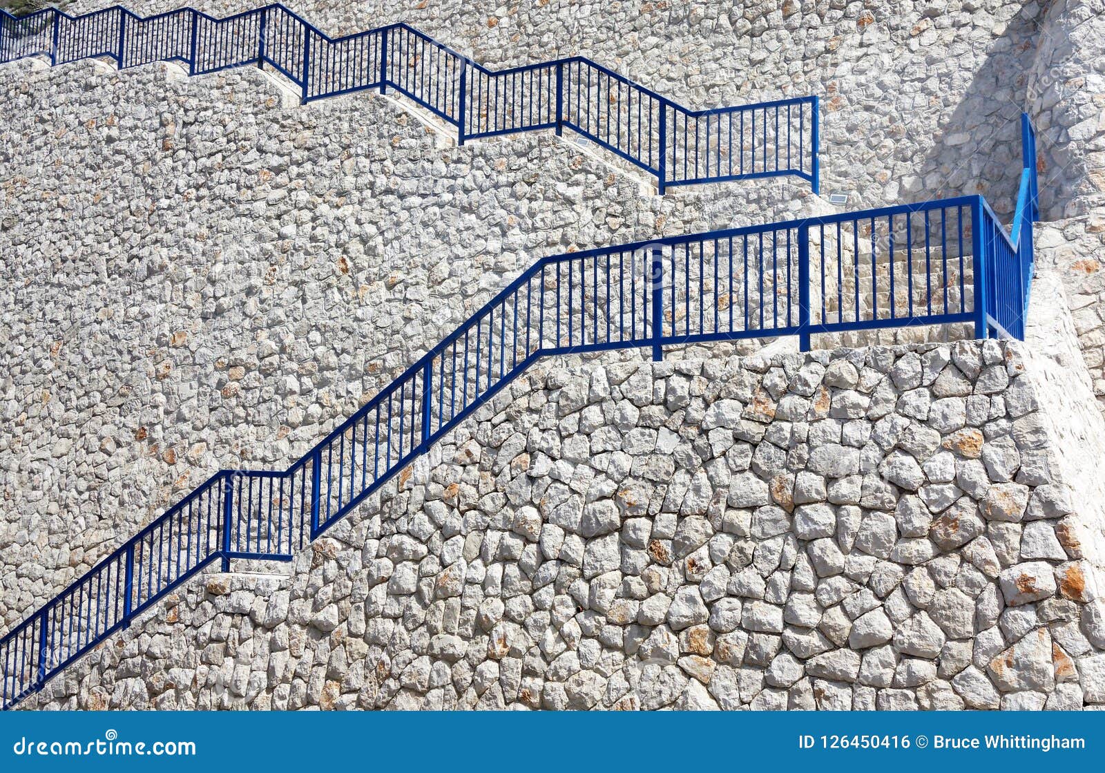 High White Rock Retaining Wall and Blue Stair Rails, Croatia Stock ...