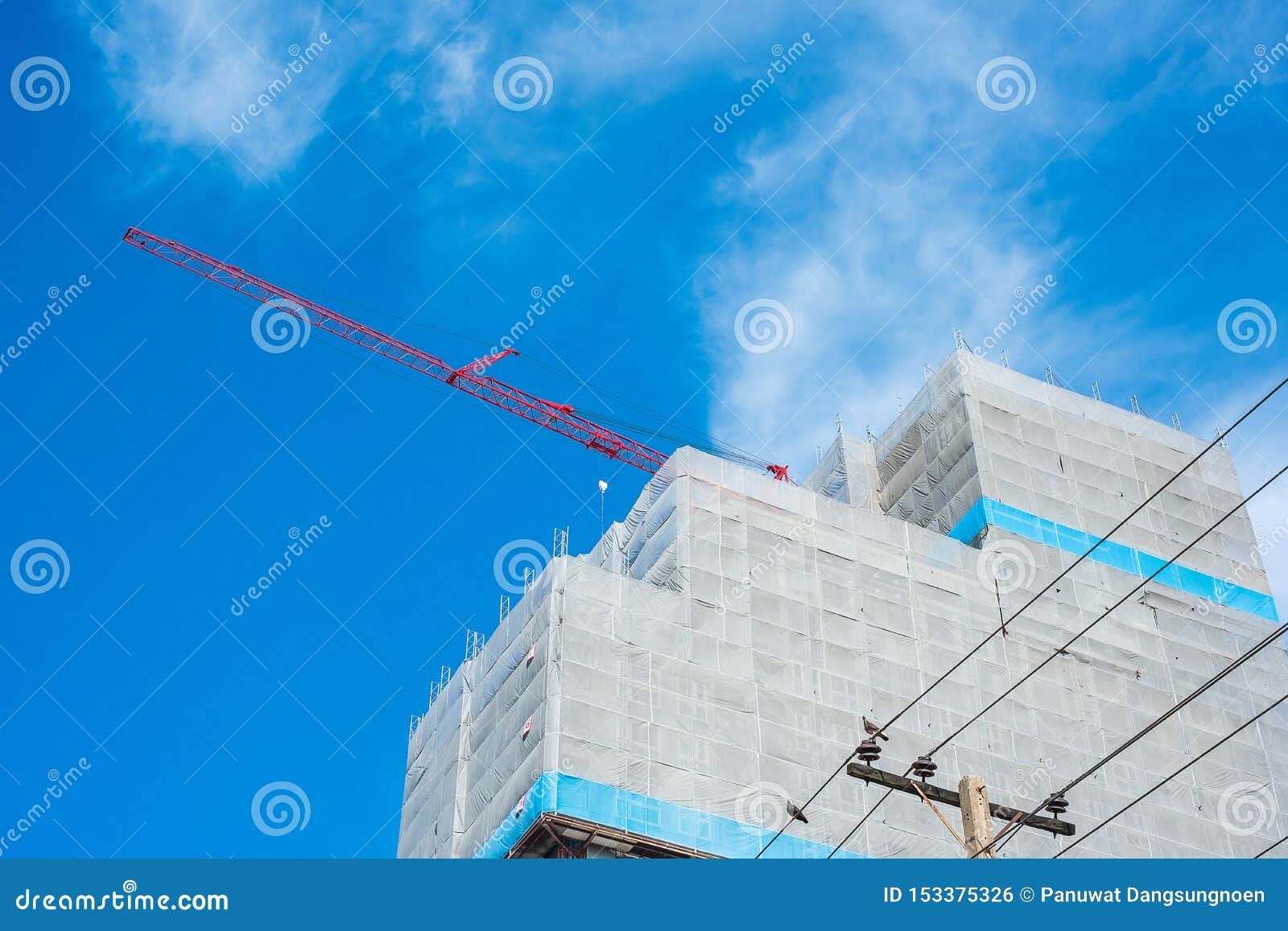 High Rise Building Construction Site with Crane on Blue Sky Background ...