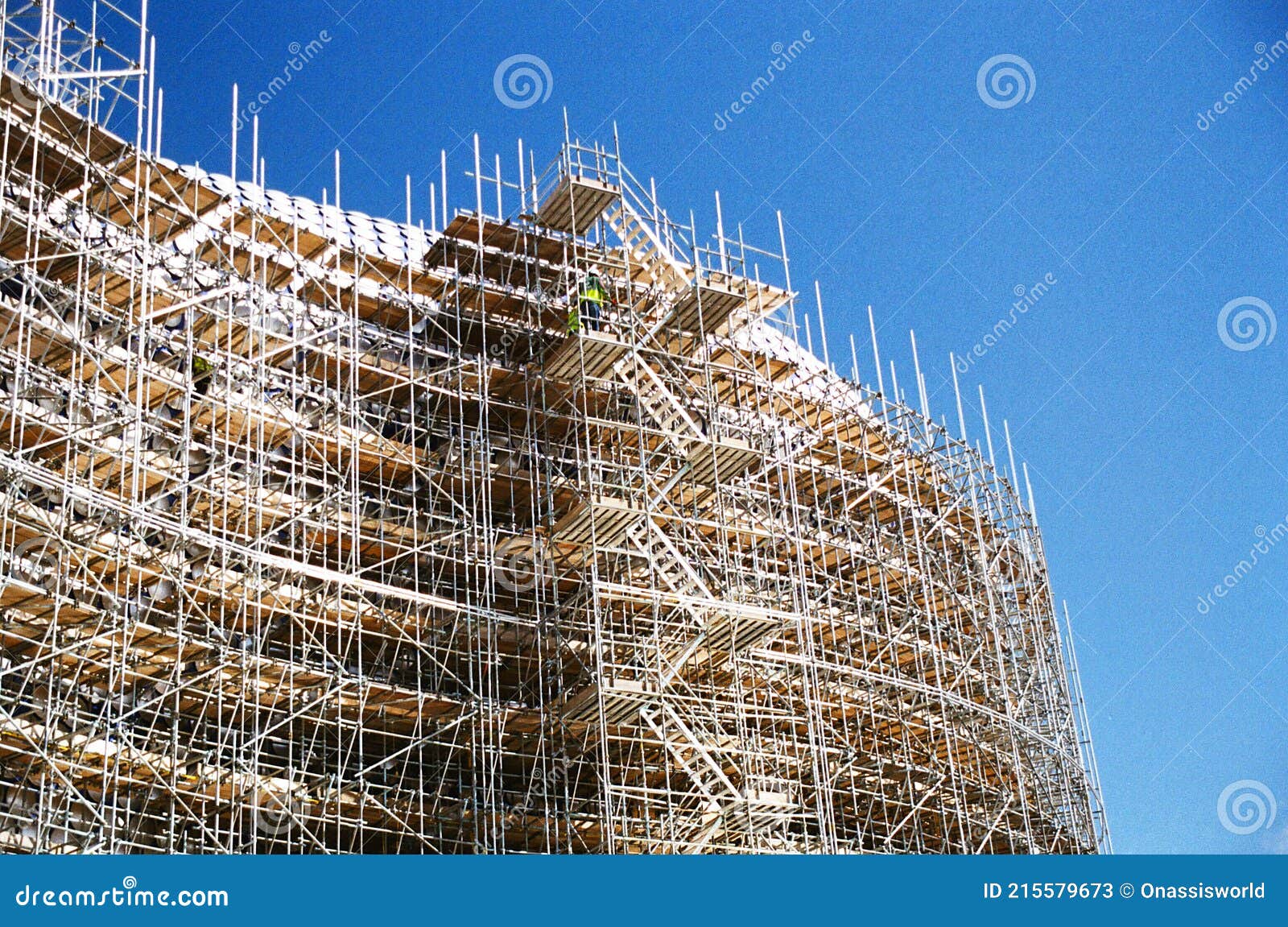 High Rise Construction Scaffolding Under a Blue Sky Stock Image - Image ...