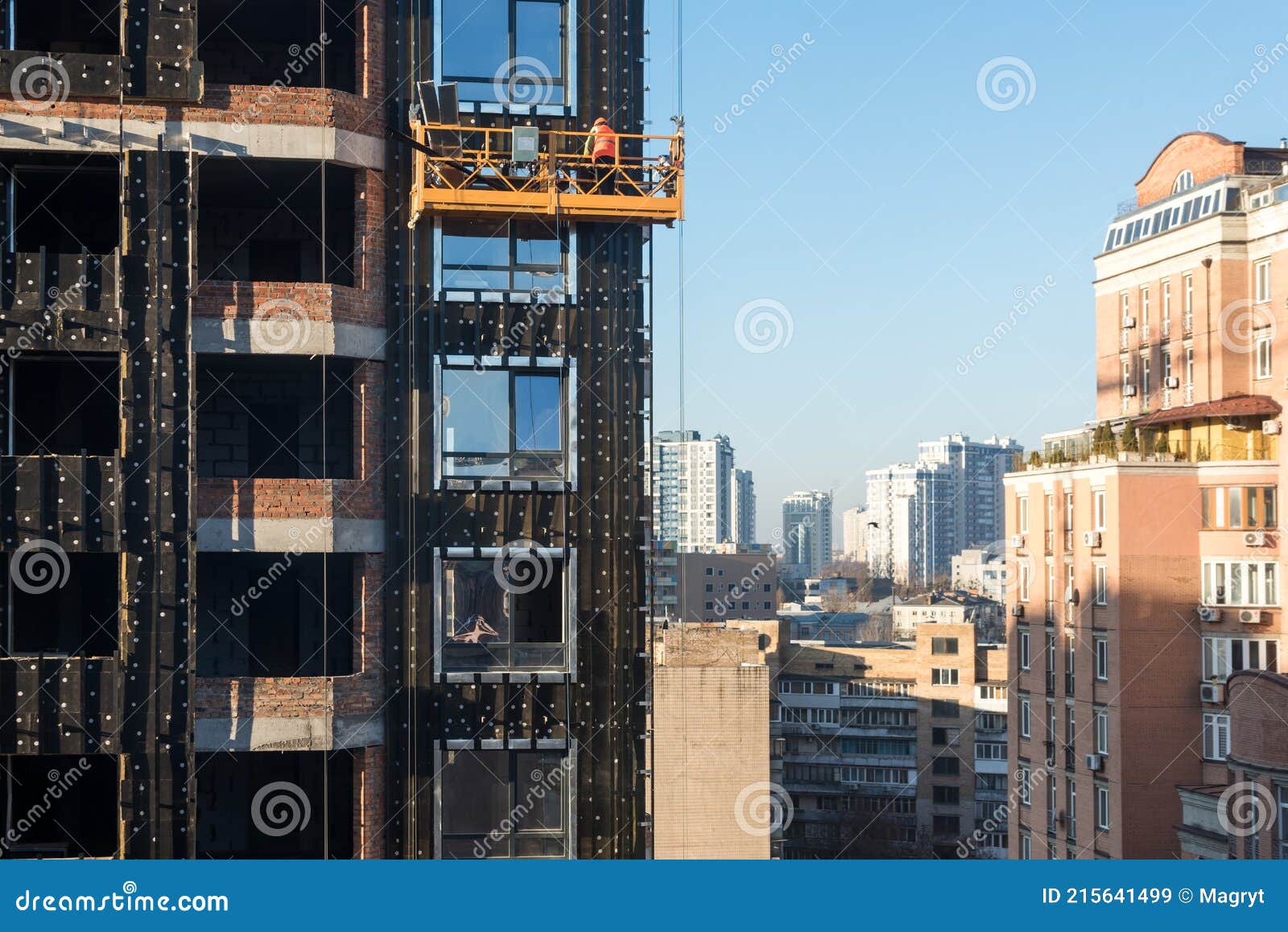 High Rise Construction Work. Construction Site Workers in Cradles ...
