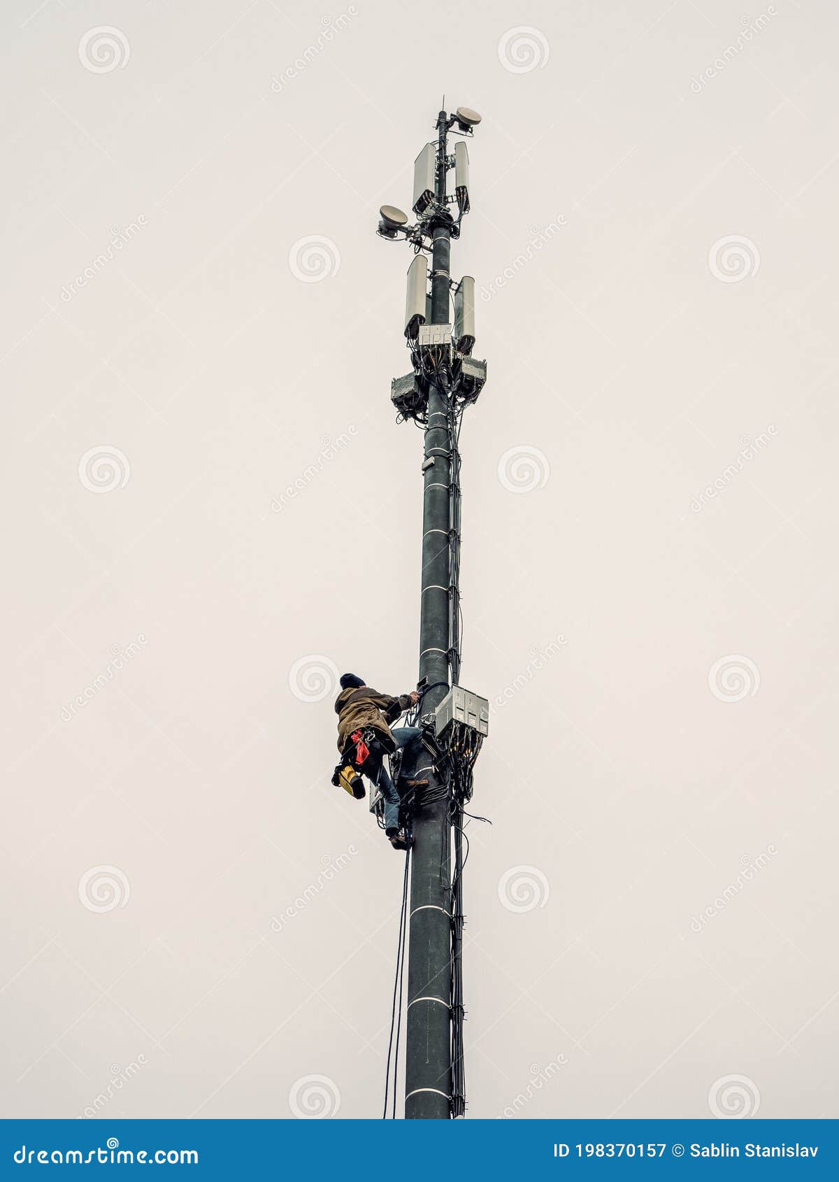 A High-rise Worker Works on a Cell Tower Stock Image - Image of mast ...