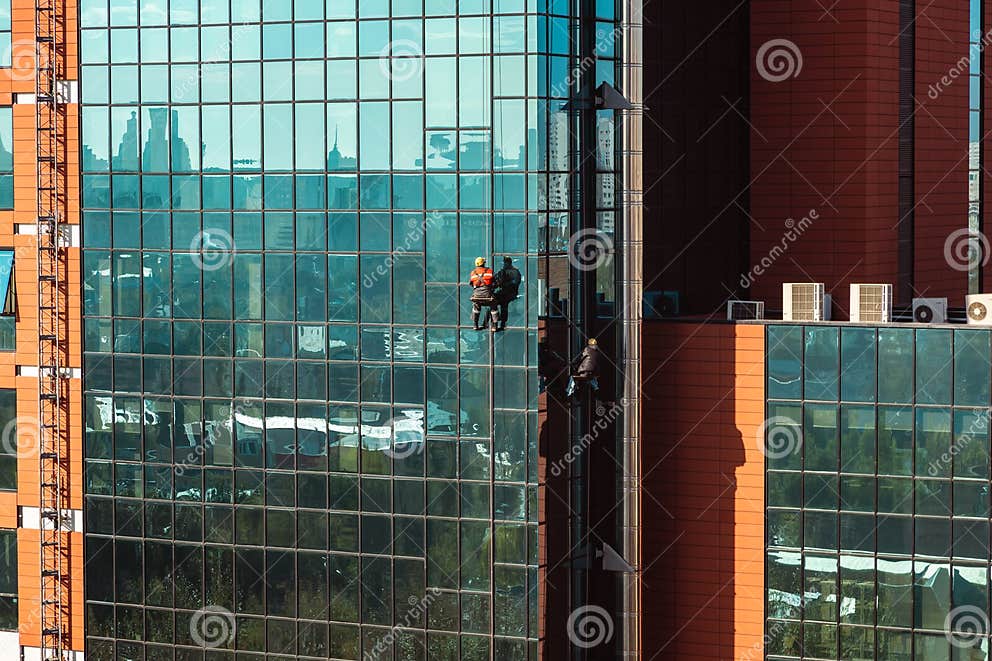 High-rise Workers Cleaning the Windows of a Skyscraper Editorial Photo ...