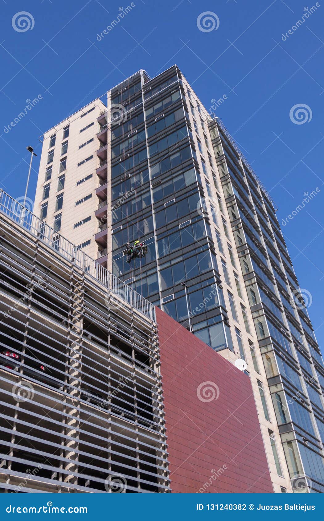 High-rise Workers with Climbing Equipment Change the Window in the High ...