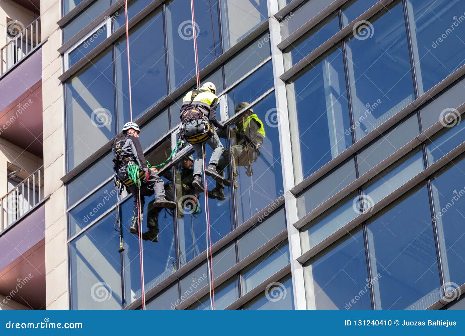 High-rise Workers with Climbing Equipment Change the Window in the High ...
