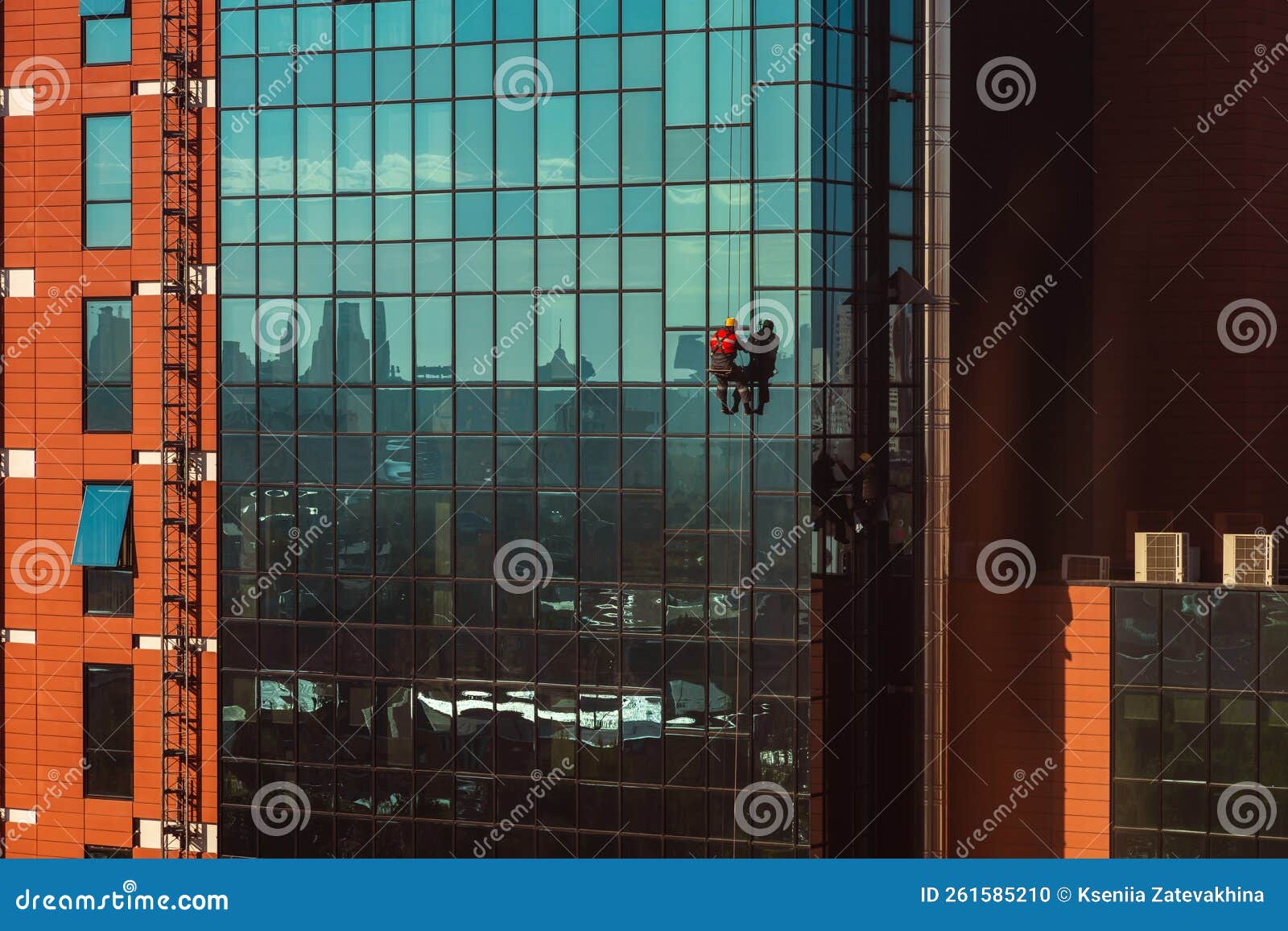 High-rise Workers Wash the Facade and Glass of a Skyscraper Editorial ...