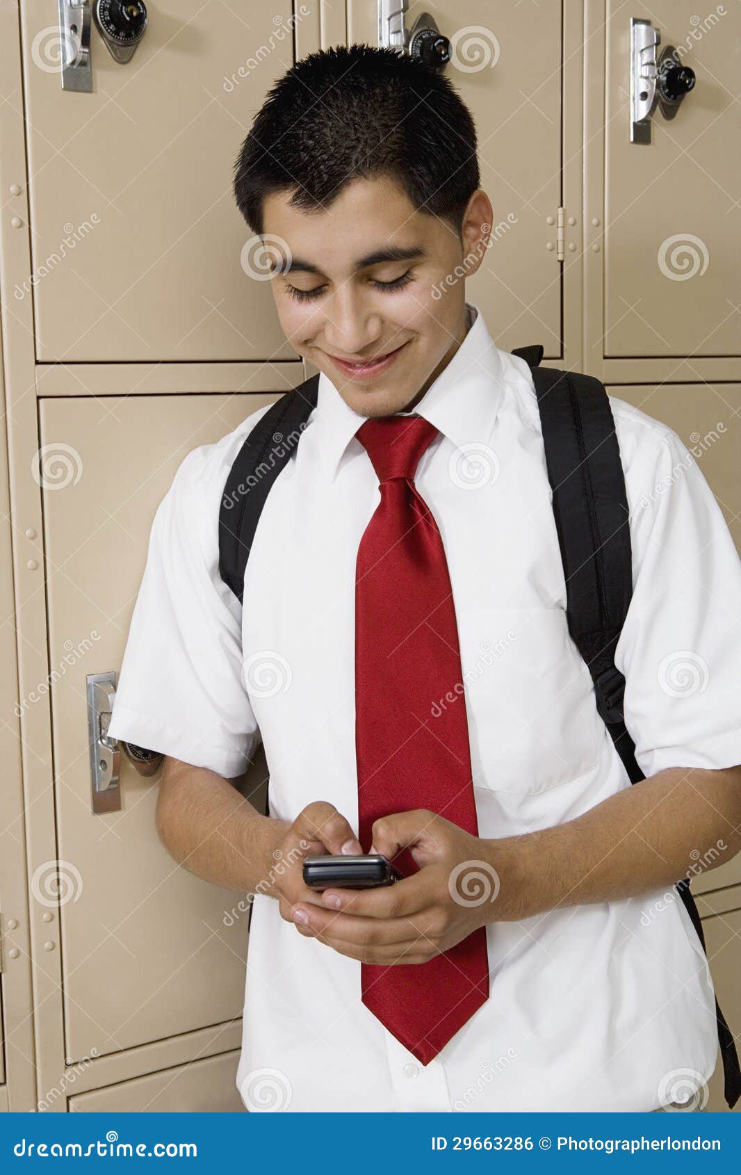 High School Boy Text Messaging by School Lockers Stock Photo - Image of ...
