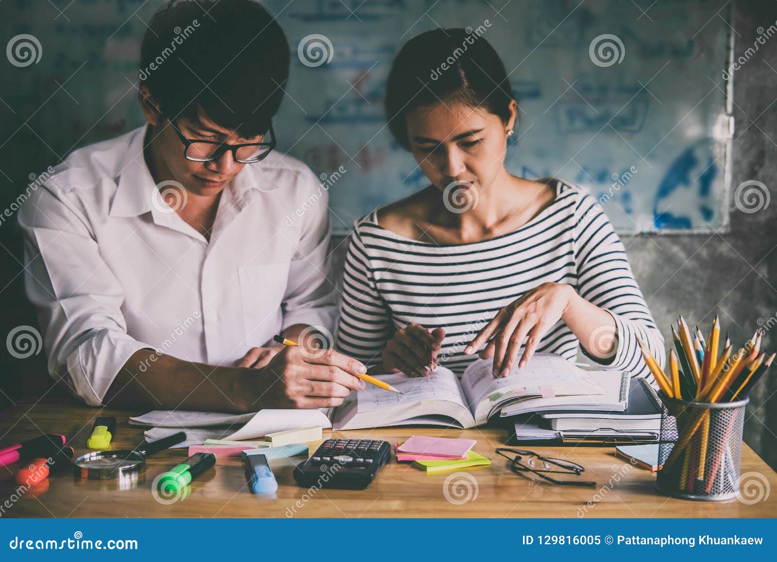High School or College Asian Student Group Sitting at Desk in Cl Stock ...