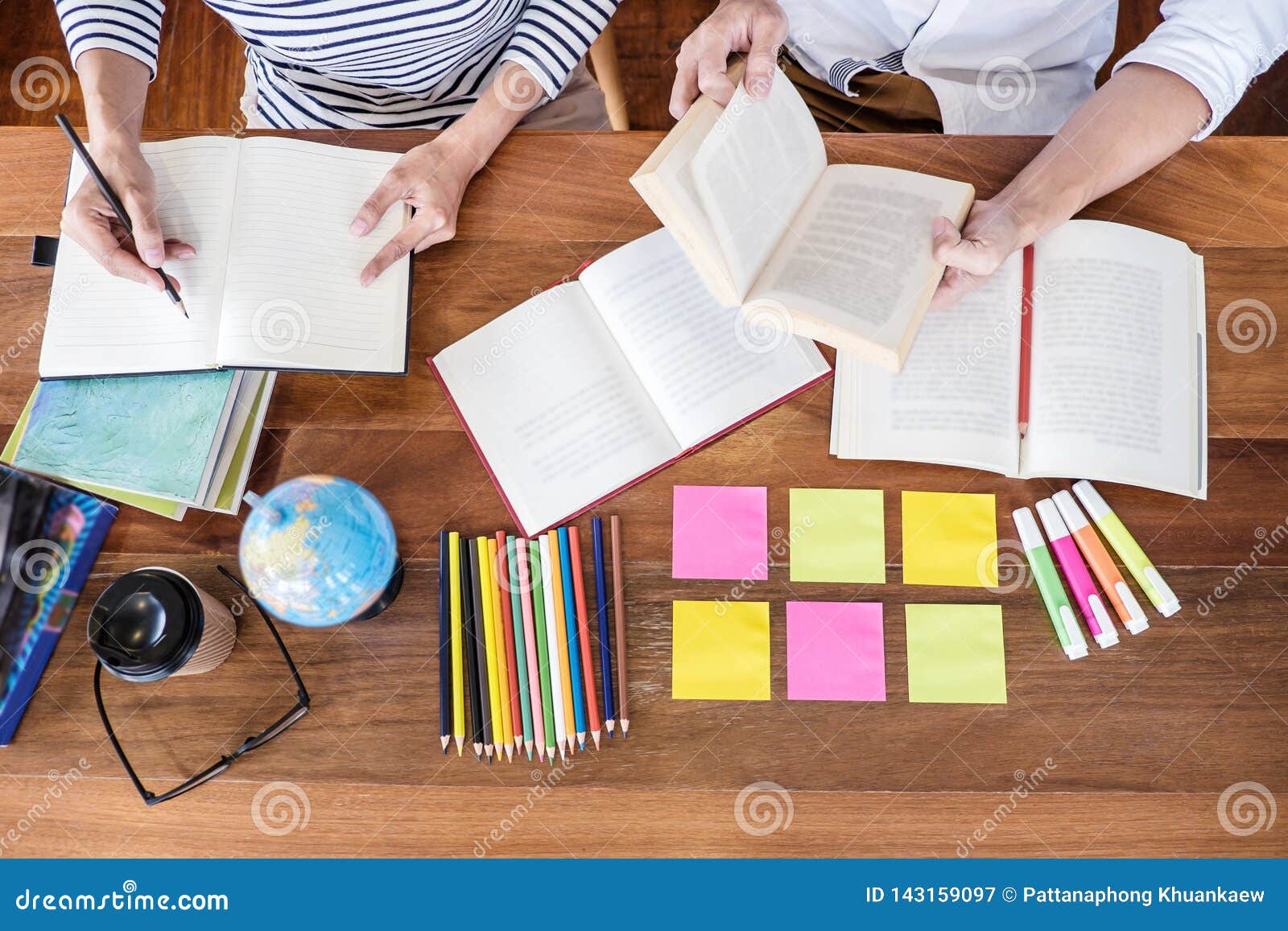 High School or College Student Group Sitting at Desk in Library ...