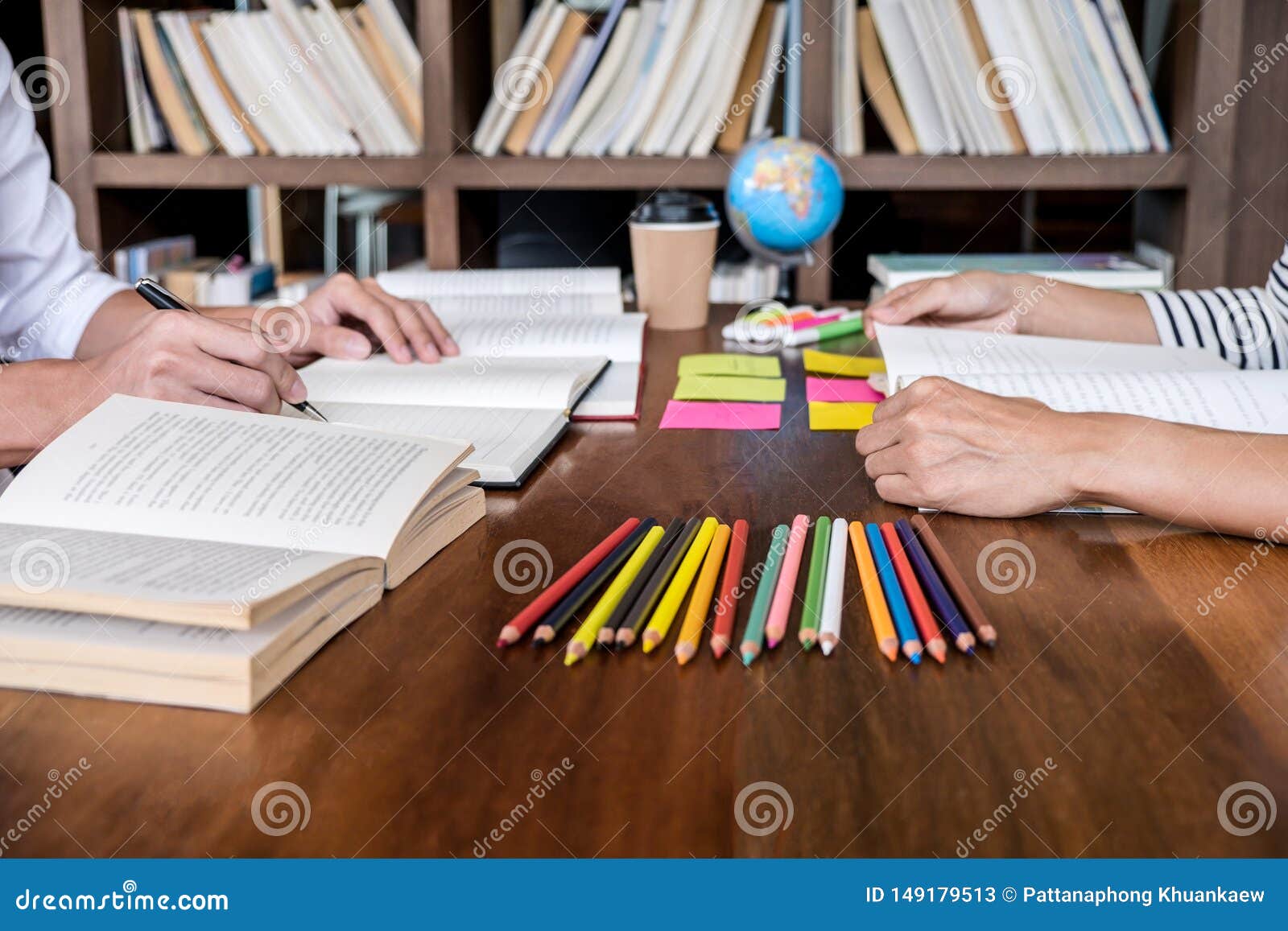High School or College Student Group Sitting at Desk in Library ...
