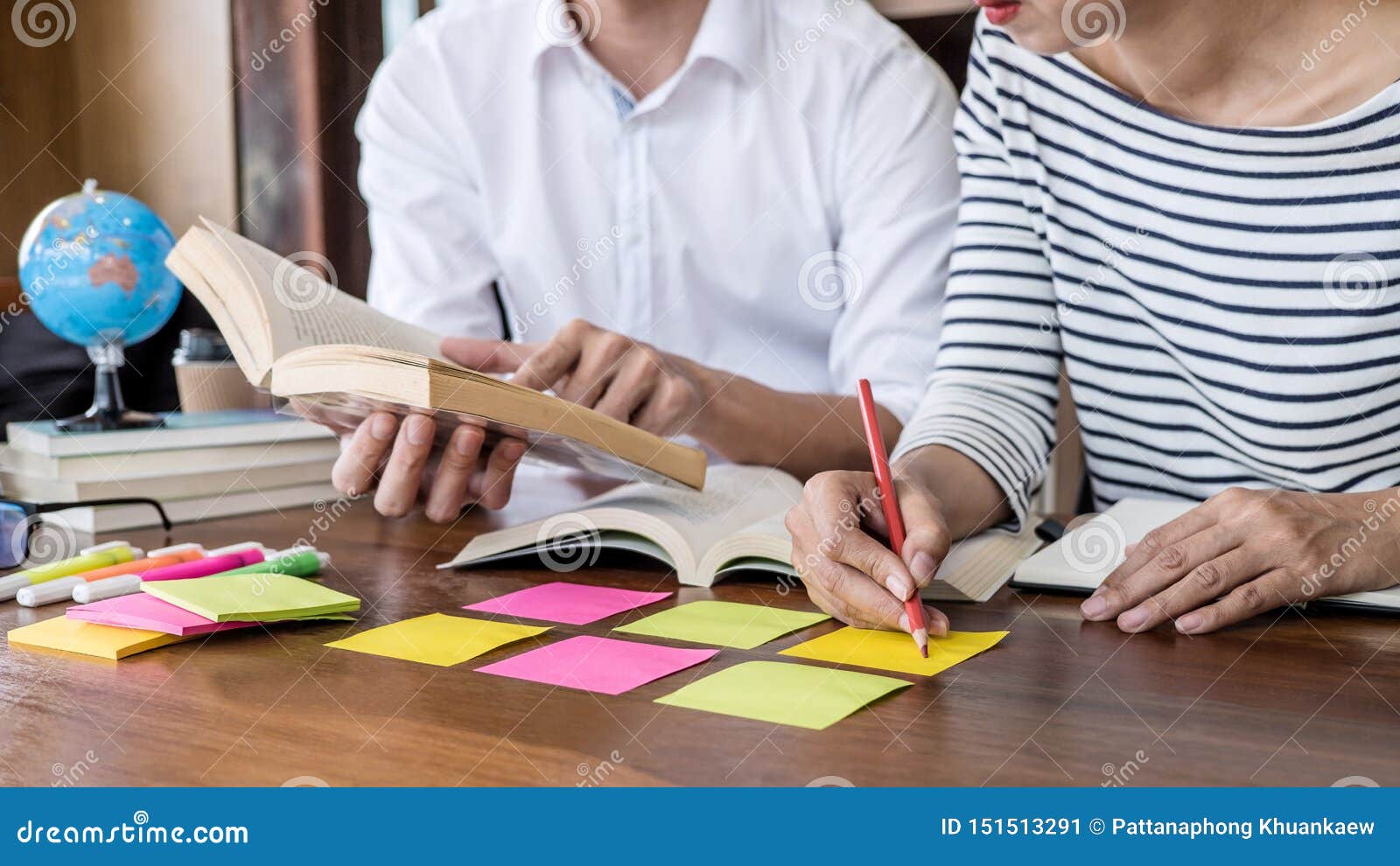 High School or College Student Group Sitting at Desk in Library ...