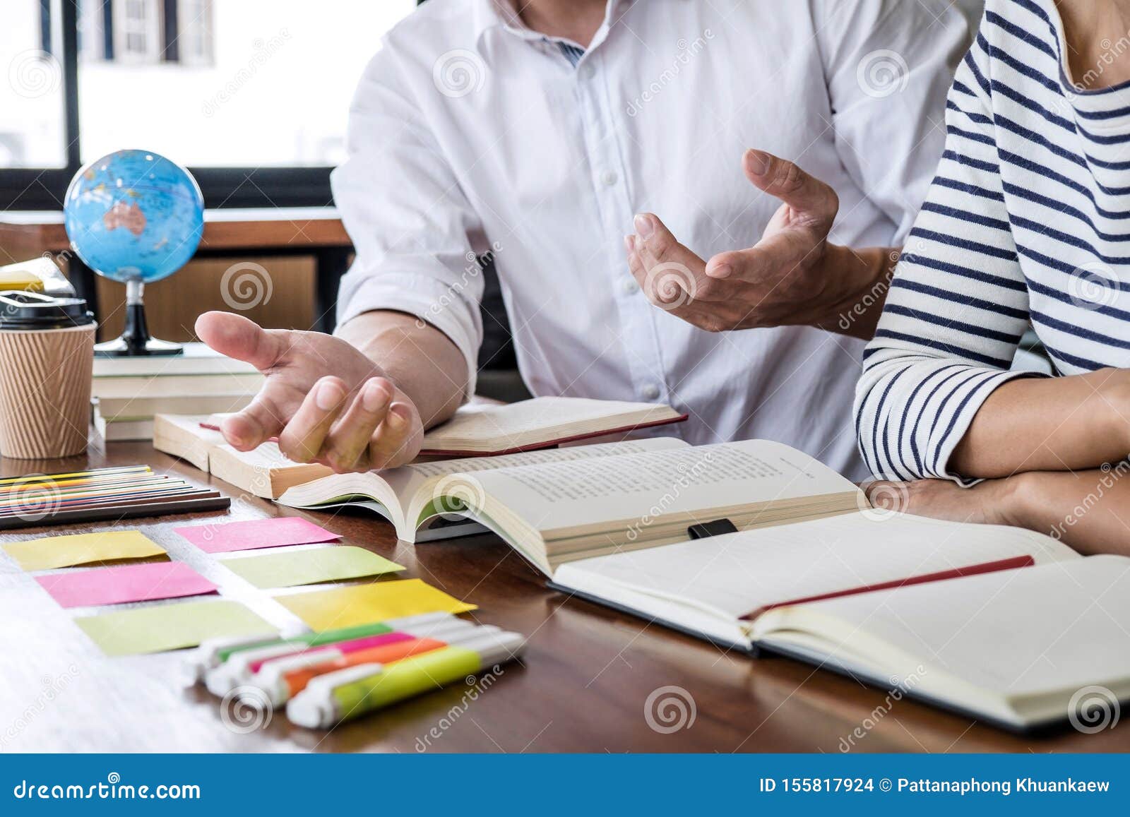 High School or College Student Group Sitting at Desk in Library ...