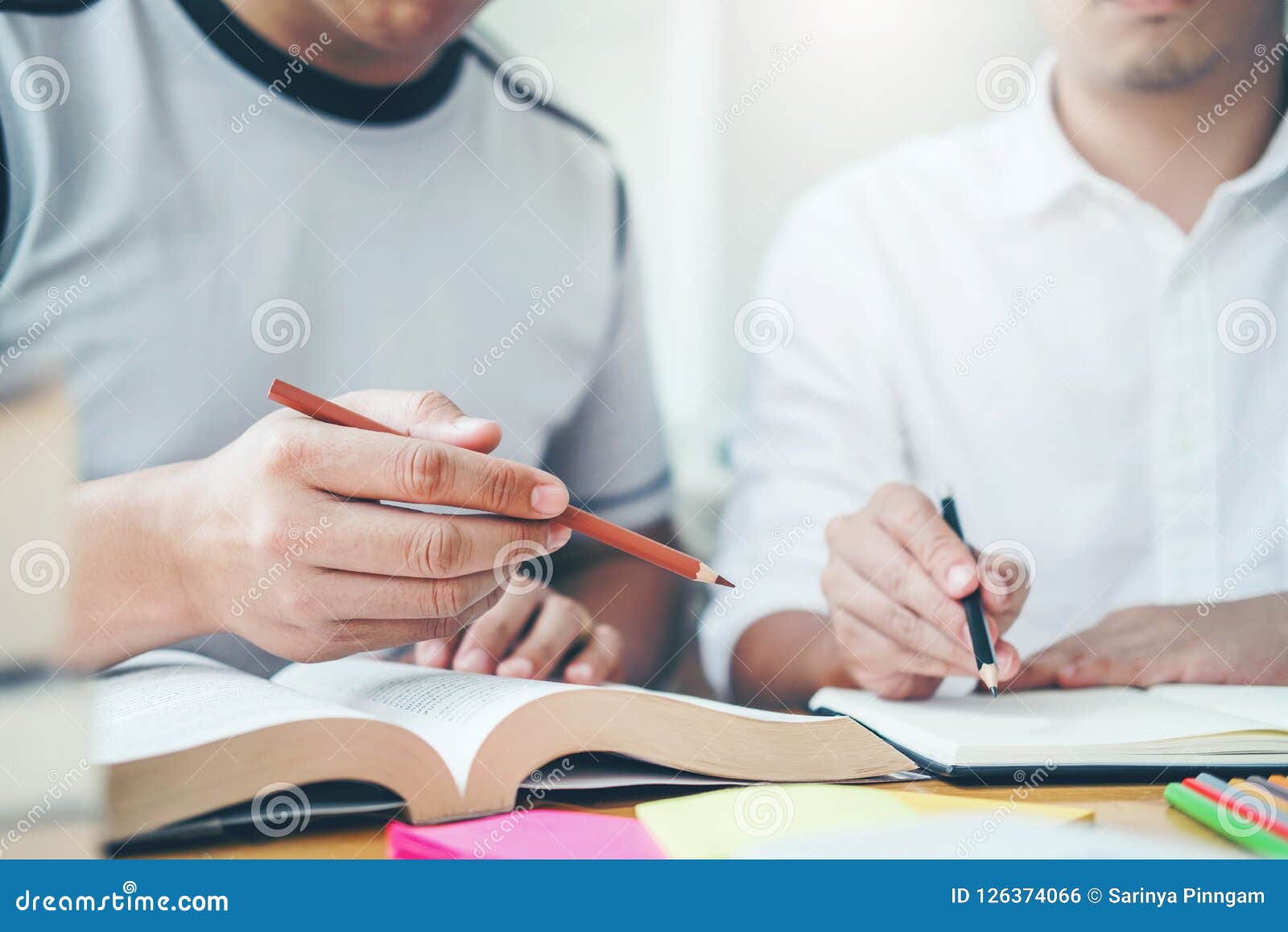 High School or College Students Studying and Reading Together in Stock ...