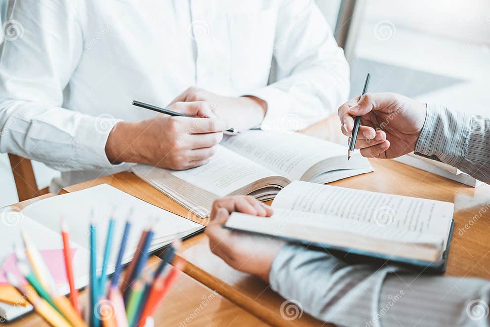 High School or College Students Studying and Reading Together in ...