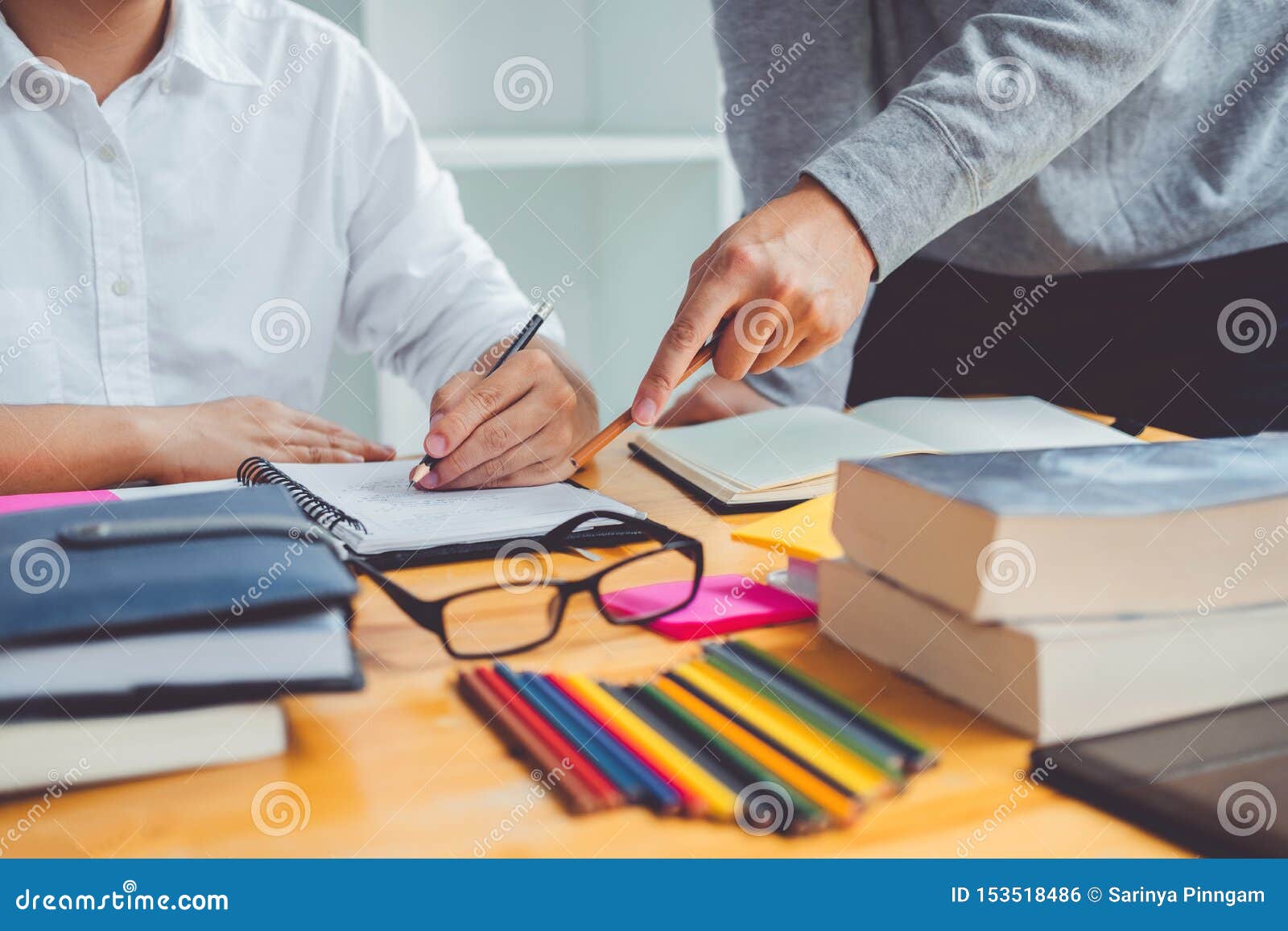 High School or College Students Studying and Reading Together in ...