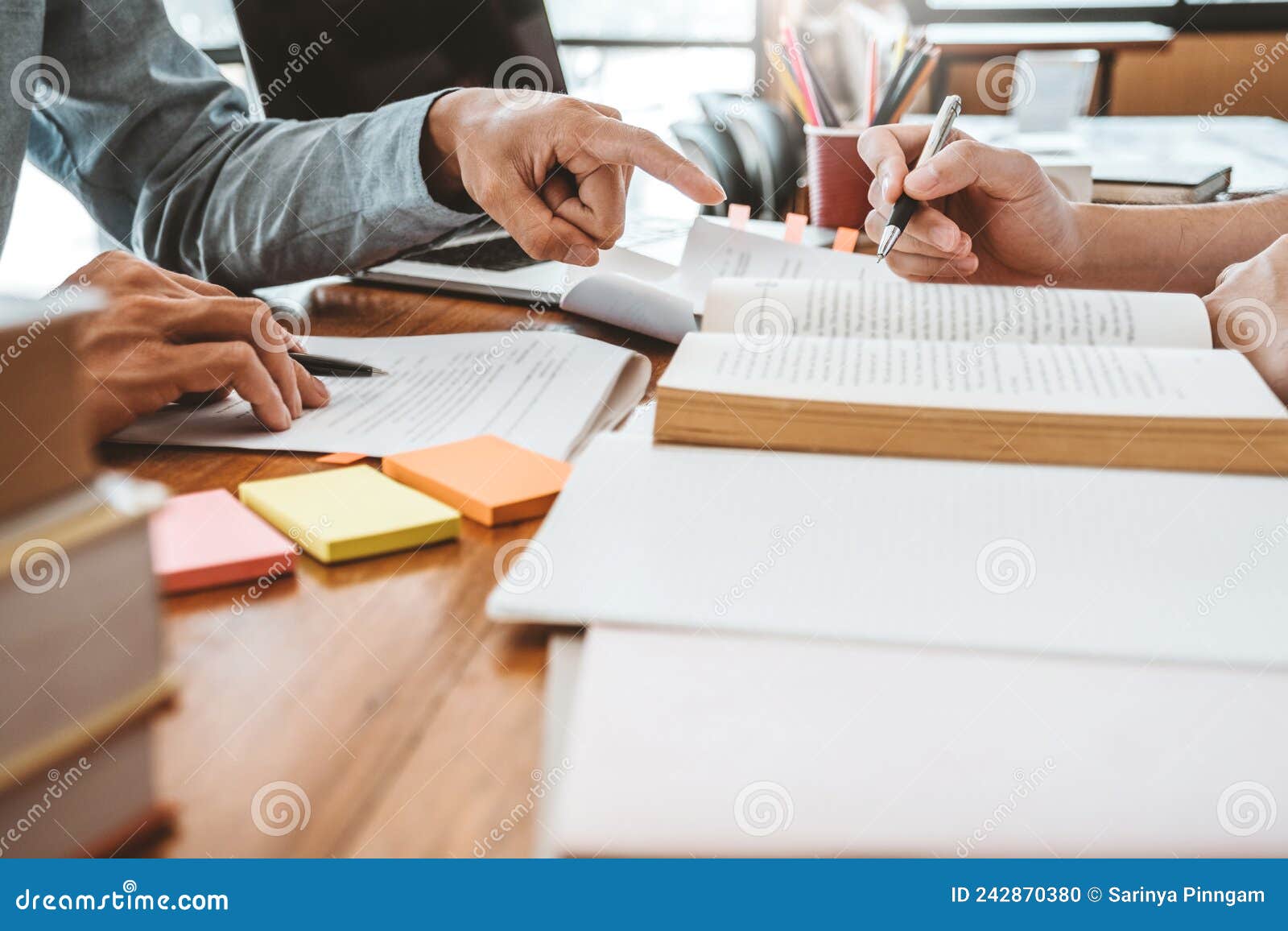 High School or College Students Studying and Reading Together in ...