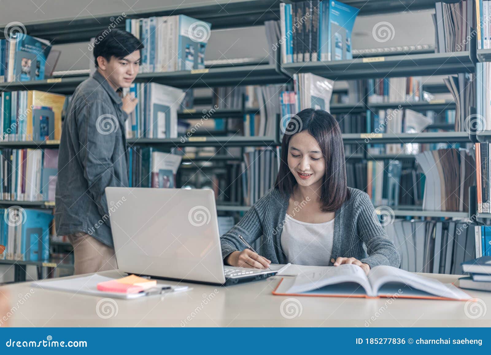 High School or College Students Studying and Reading Together in ...