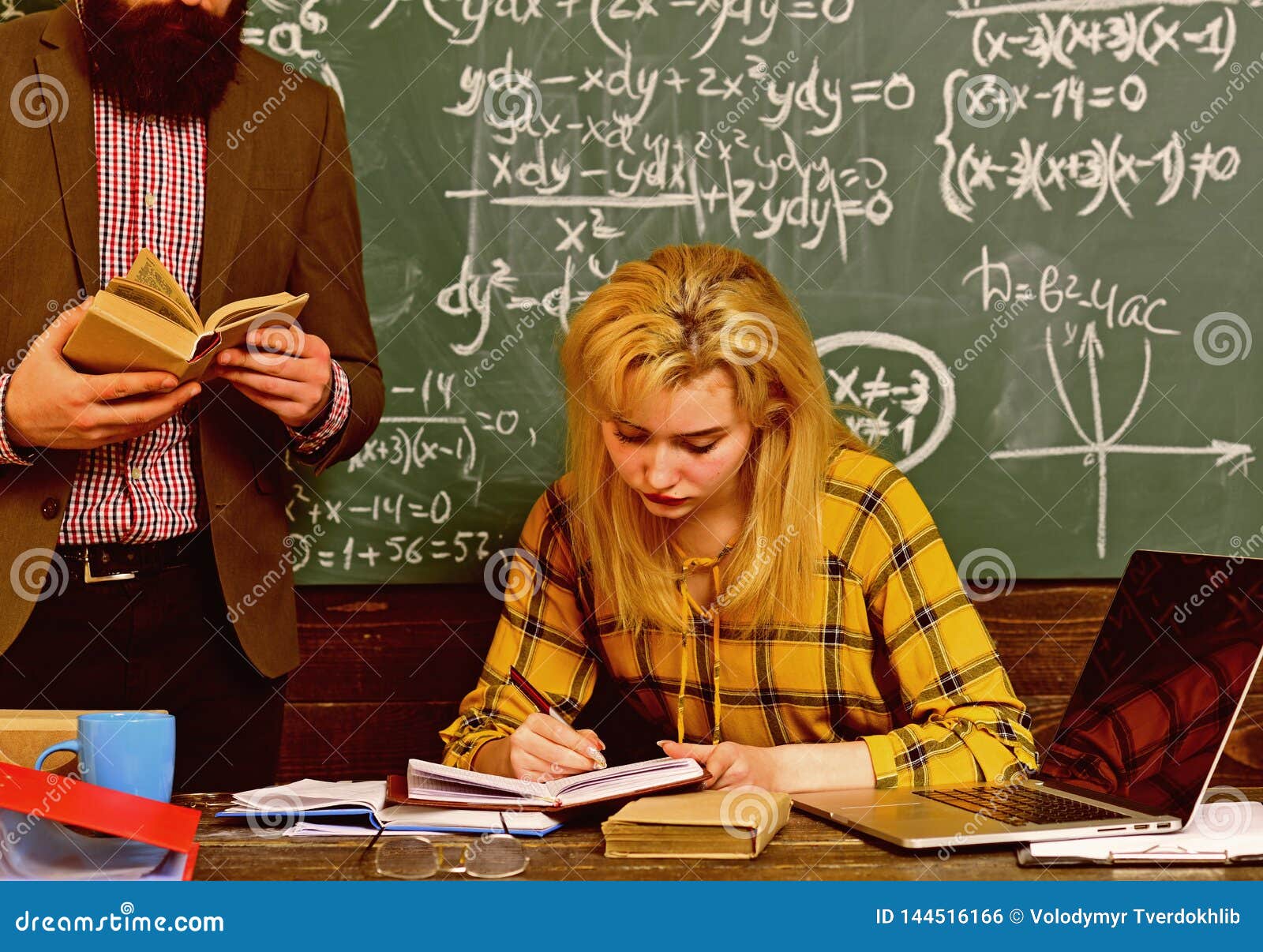 High School or College Students Studying and Reading Together in ...