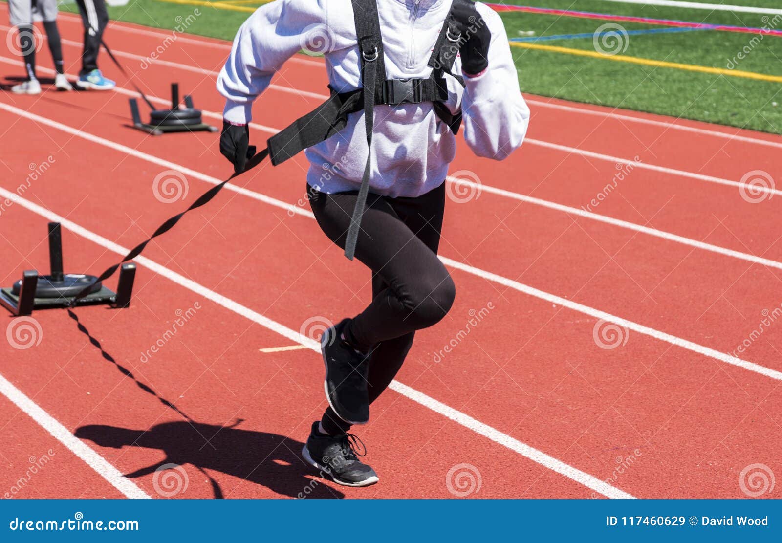 High School Girls Running Toward Camera Pulling a Sled with Weights ...