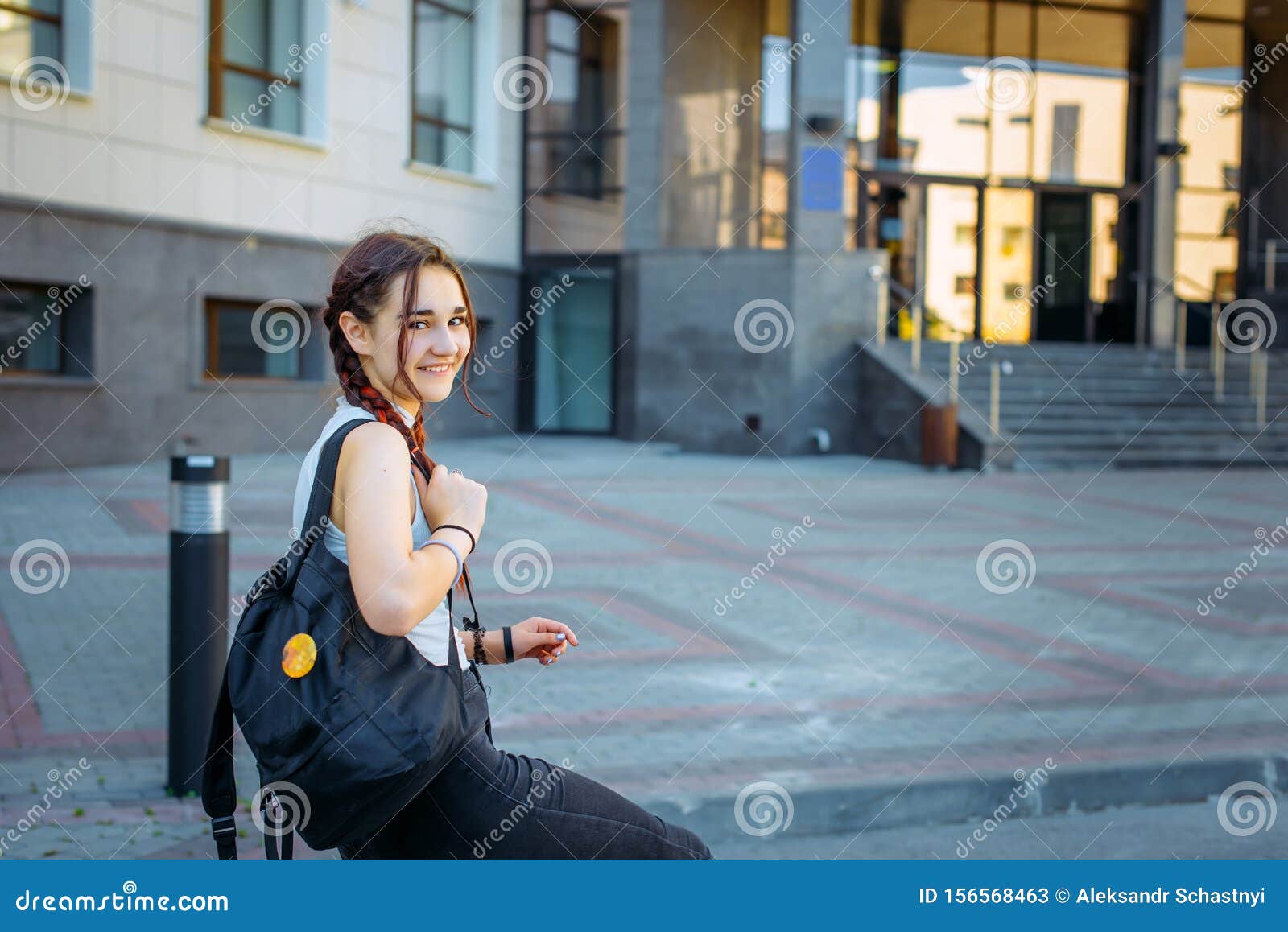 A High School Student with a Backpack Stands on the University Yard ...