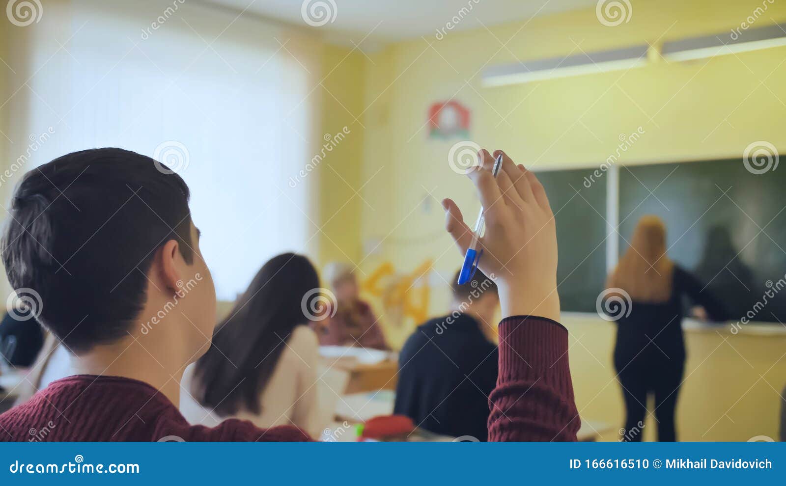 High School Student Raises His Hand during the Lesson. Stock Photo ...