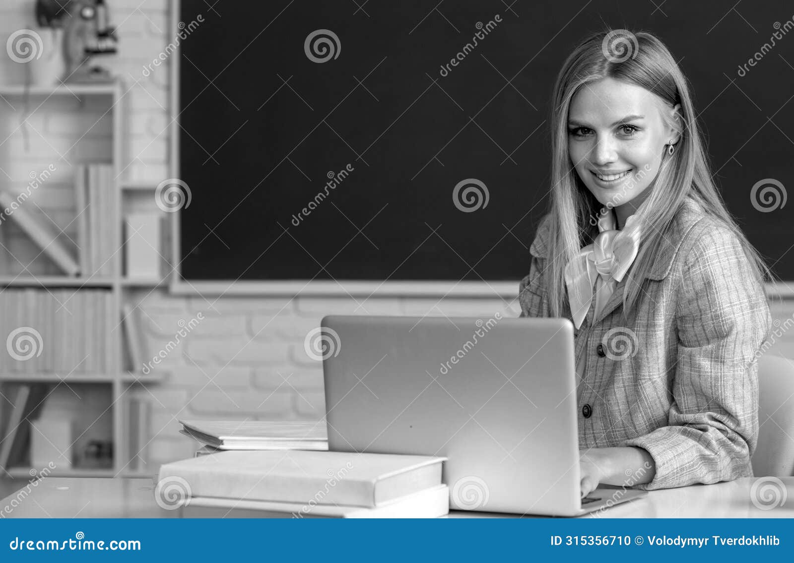 High School Student Sitting at Table and Writing on Notebook, Learning ...