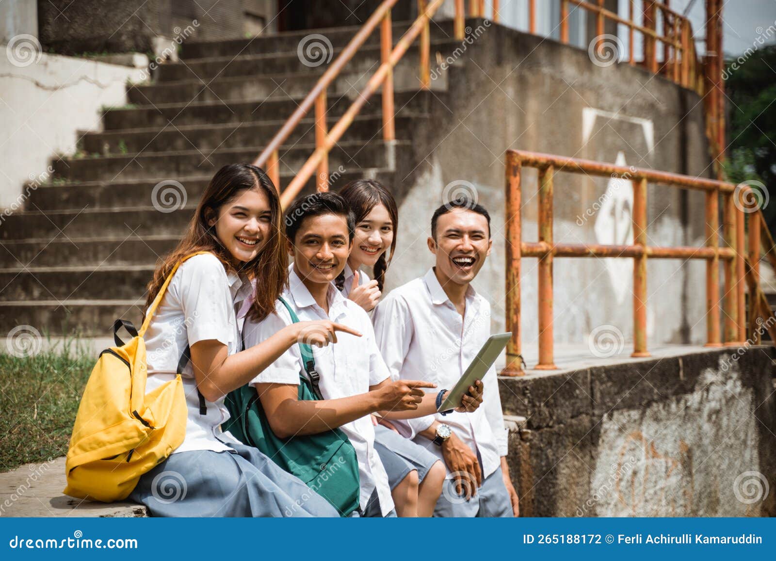 High School Student Using Tablet with Pointing Looking at Camera Stock ...