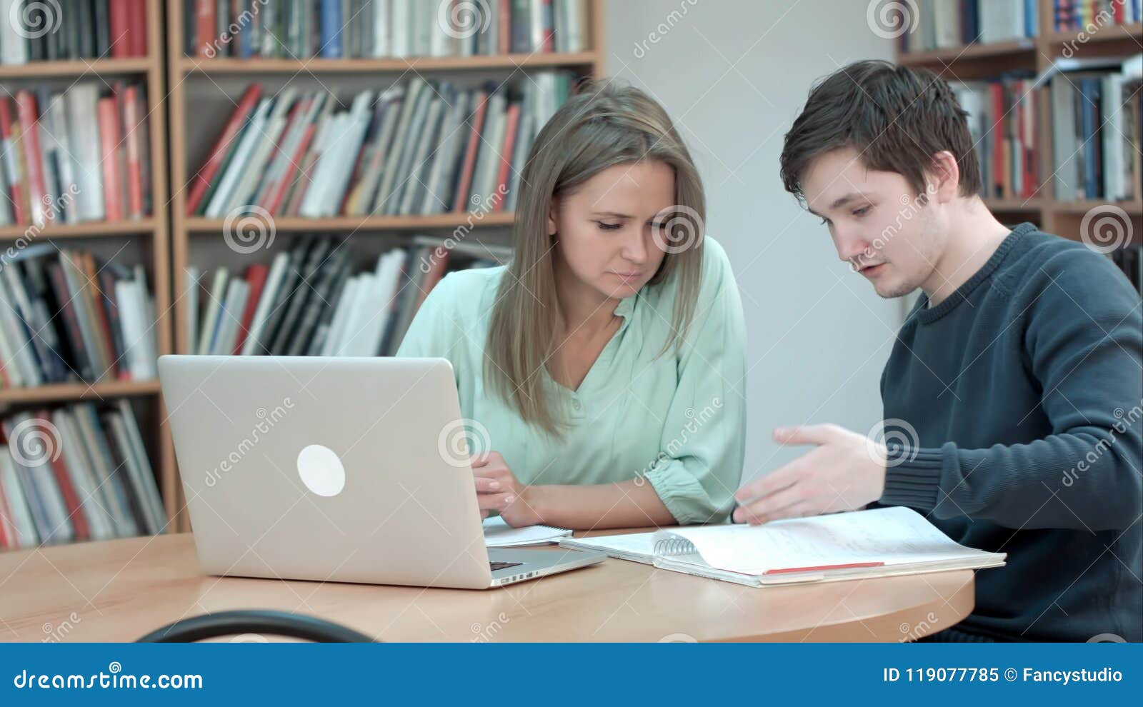 High School Student Working in Library after Classes, Using Laptop ...