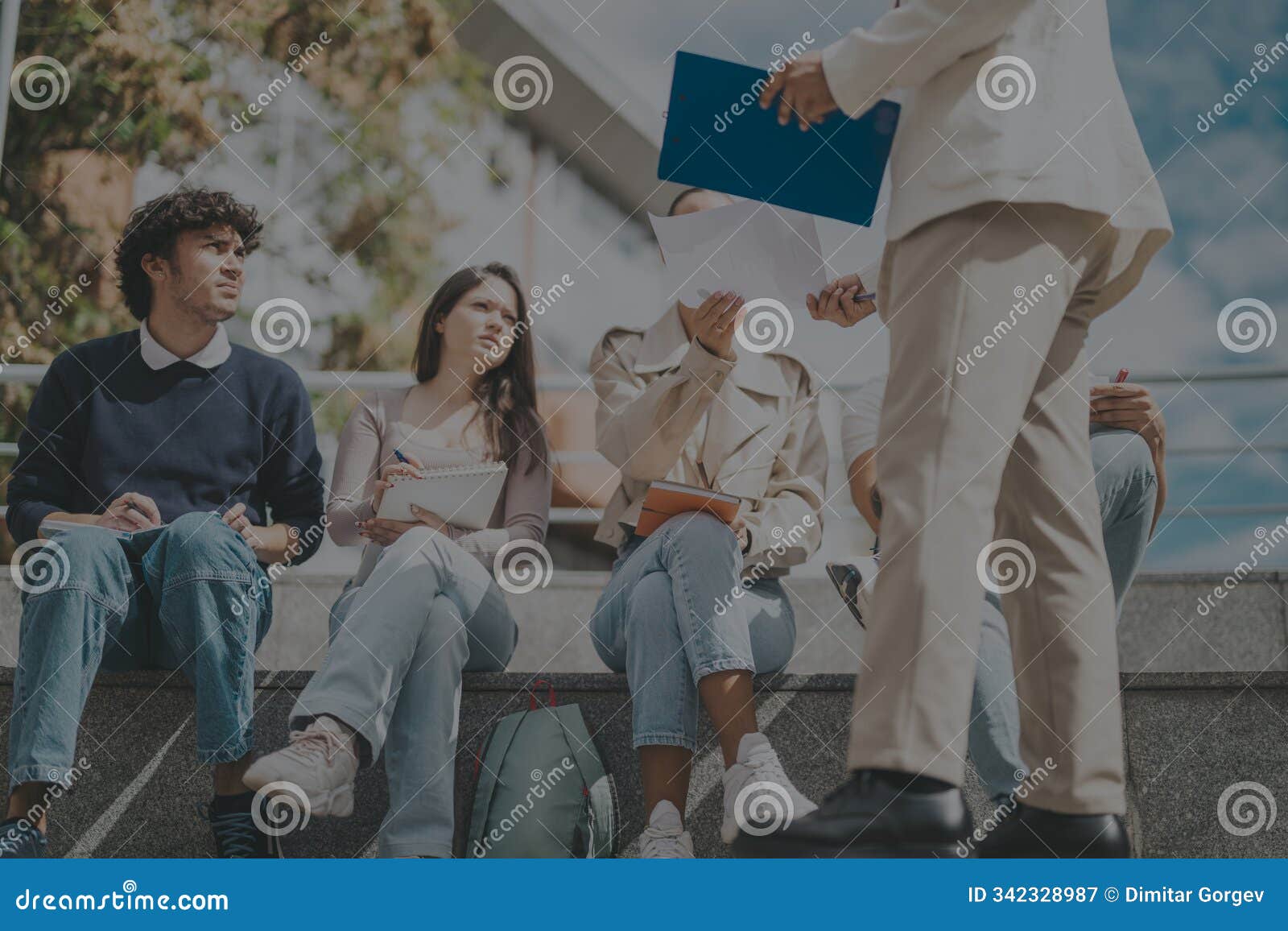 High School Students Collaborating with Professor Outside on Campus ...