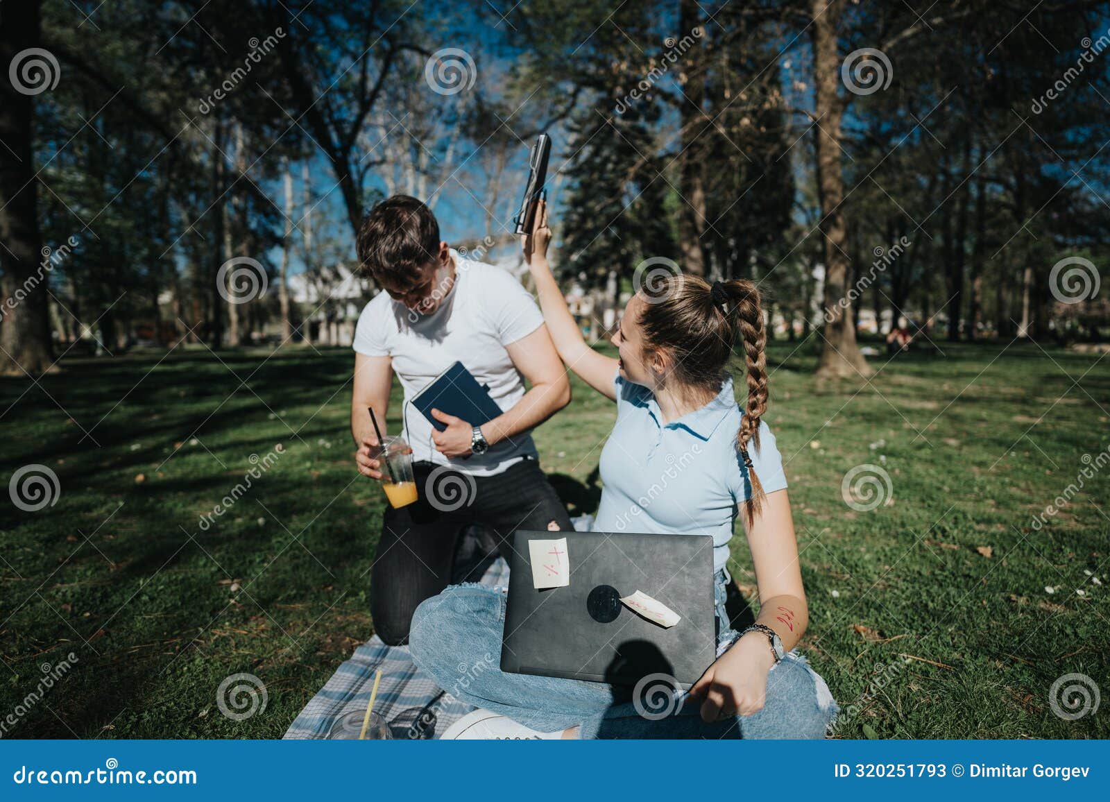 High School Students Collaborating on a Project in a Campus Park Stock ...
