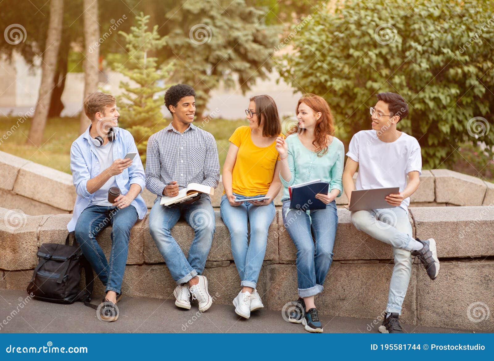 High-School Students Learning Doing Homework Together Sitting Outside ...