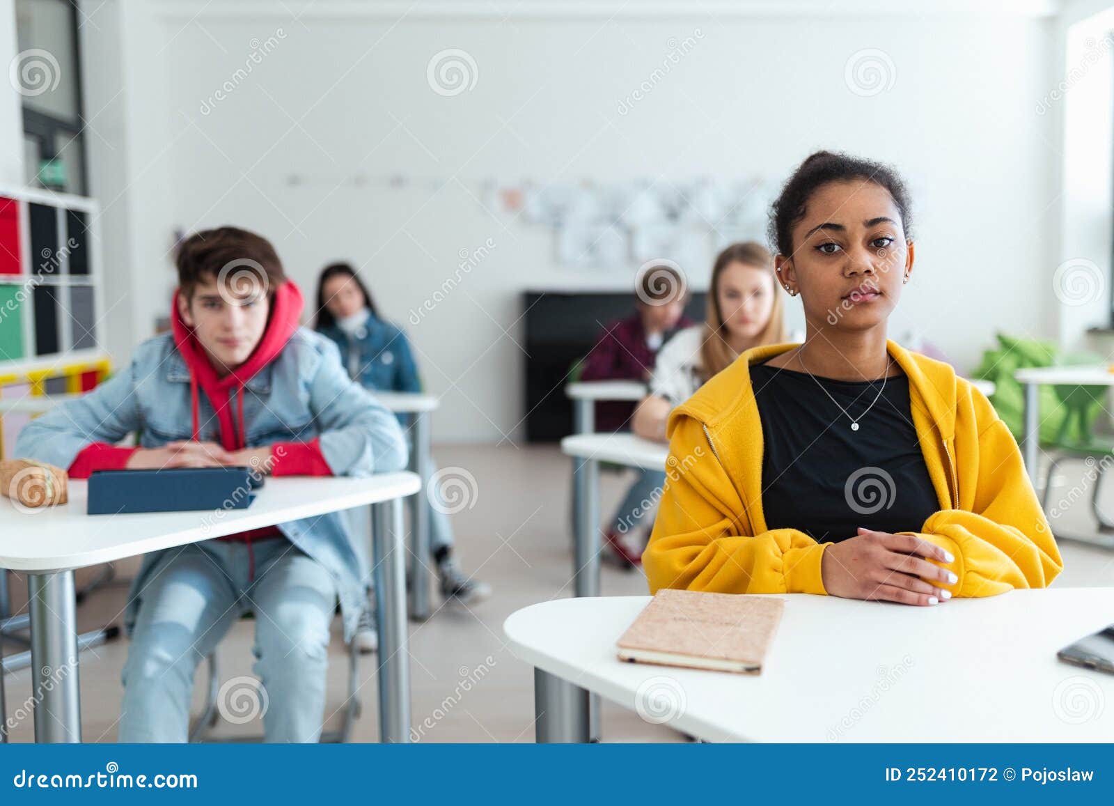 High School Students Paying Attention in Class, Sitting in Their Desks ...