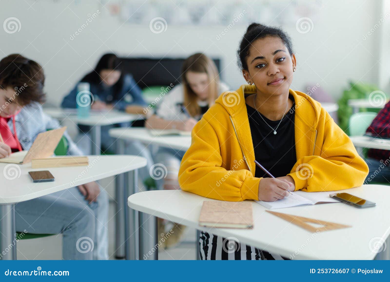 High School Students Paying Attention in Class, Sitting in Their Desks ...