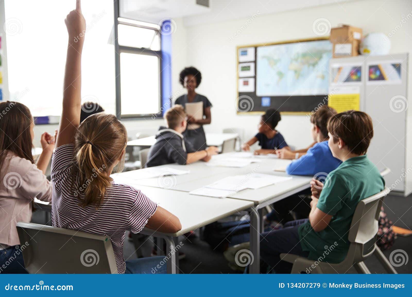 High School Students Raising Hands To Answer Question Set by Teacher in ...