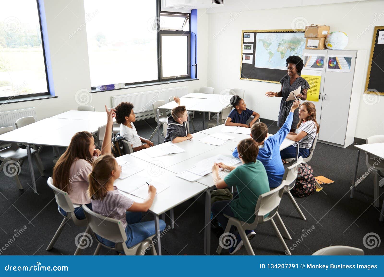 High School Students Raising Hands To Answer Question Set by Teacher in ...