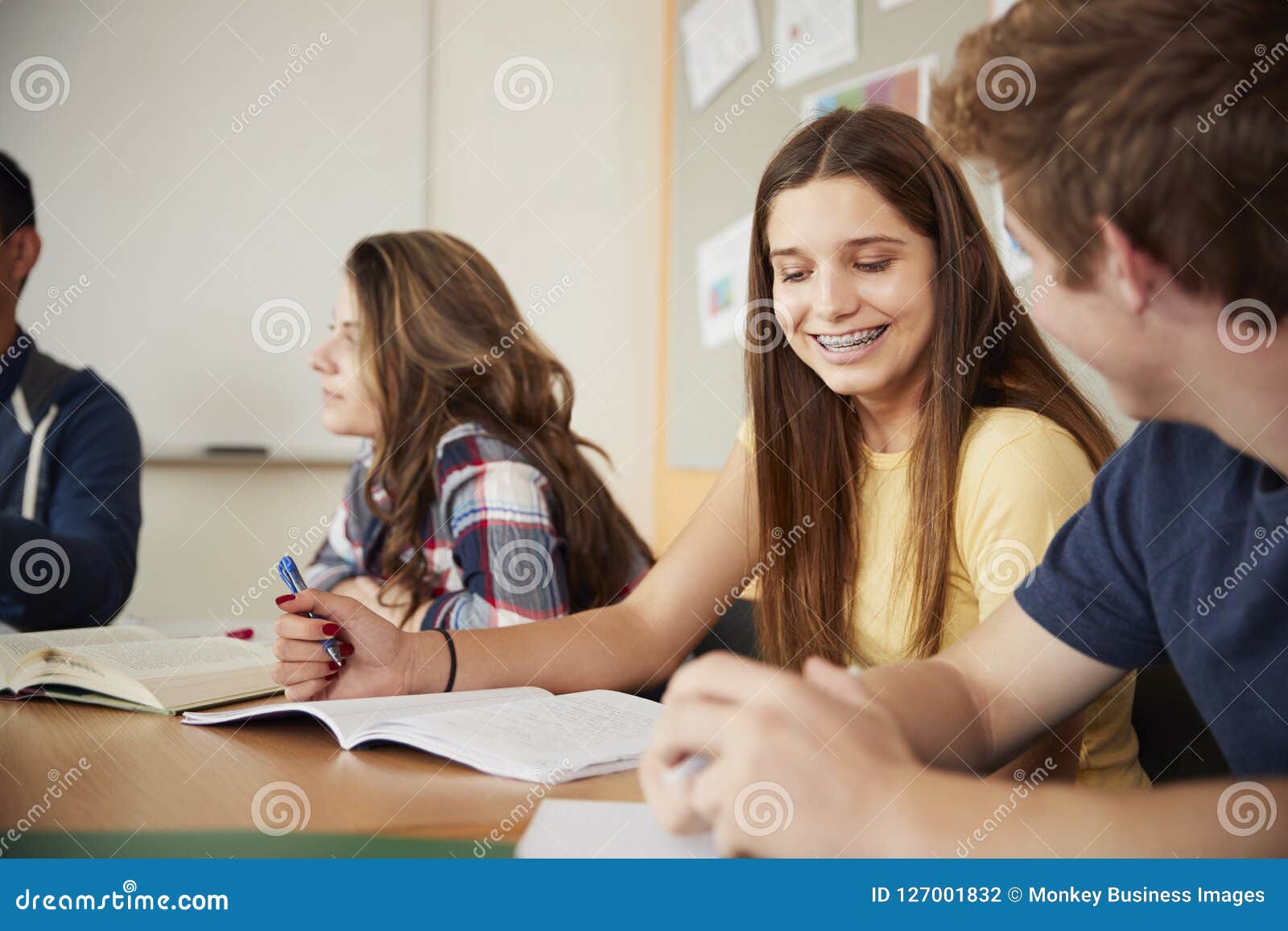 High School Students Sitting at Table Collaborating in Class Together ...