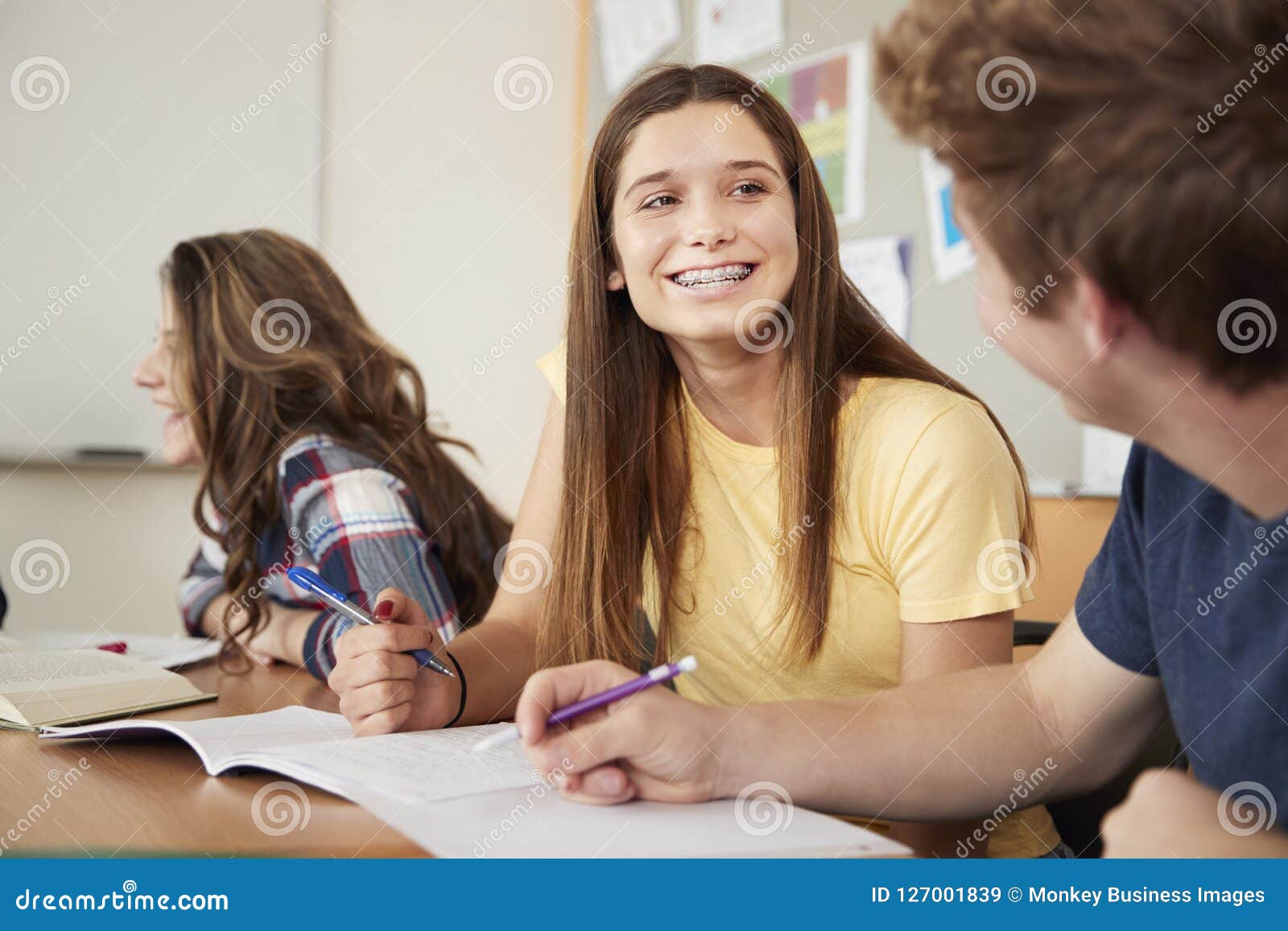 High School Students Sitting at Table Collaborating in Class Together ...