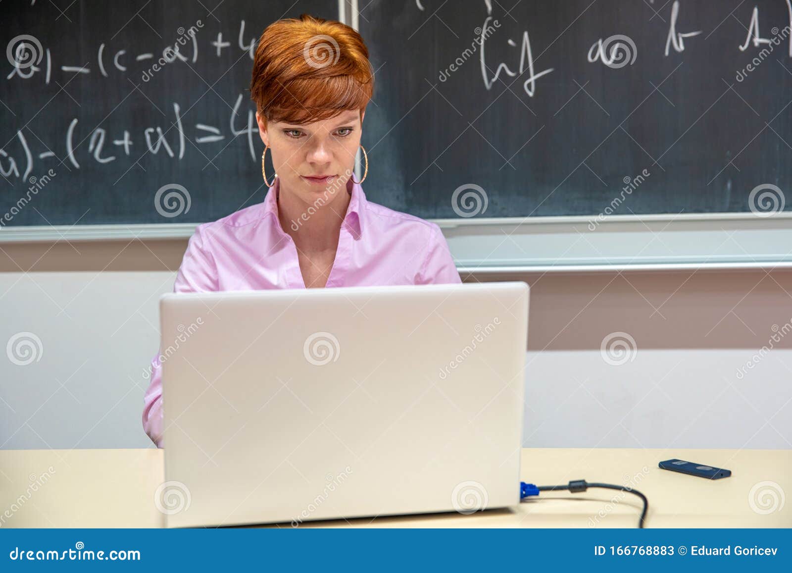 A High School Teacher Writes Homework for Students in His White Laptop ...