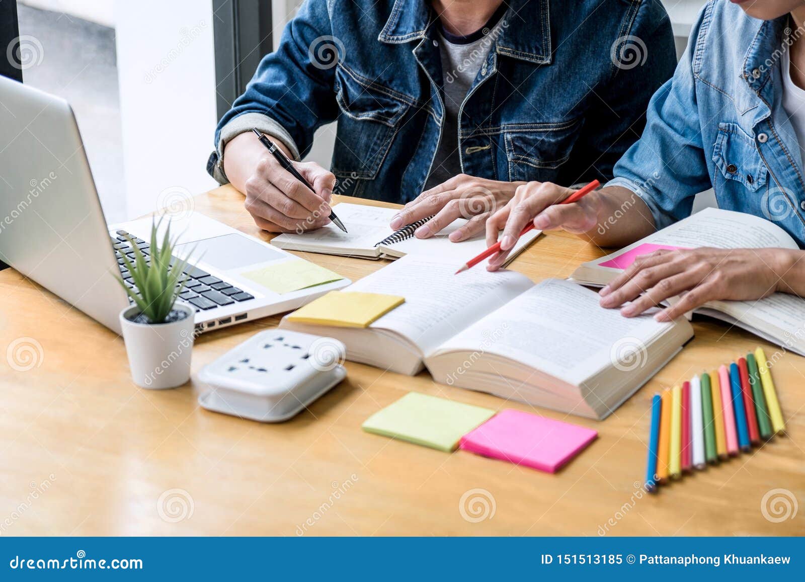 High School Tutor or College Student Group Sitting at Desk in Library ...