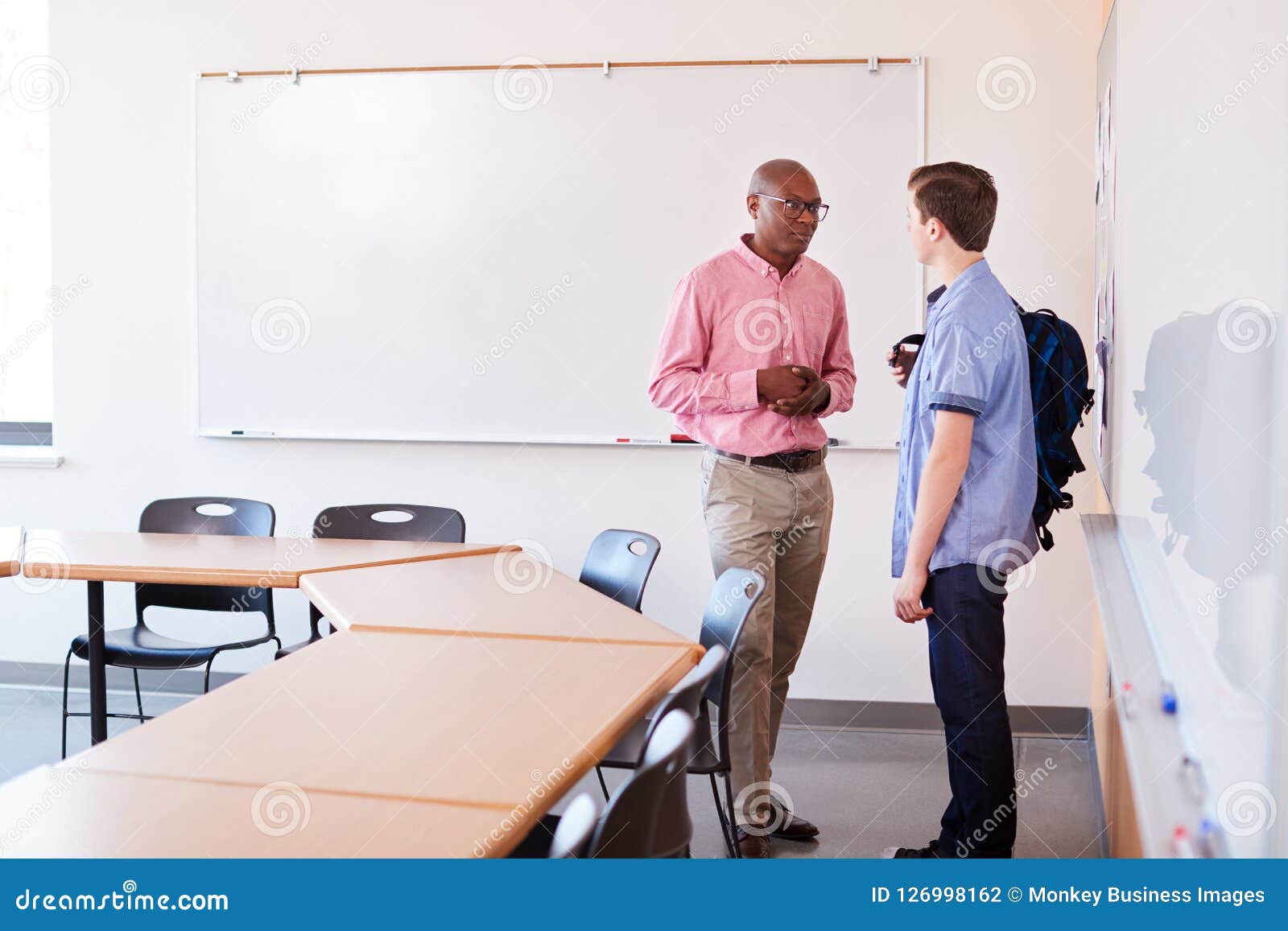 High School Tutor Talking with Male Student after Class Stock Photo ...