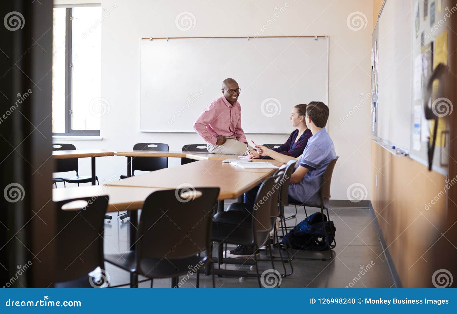 High School Tutor Talking with Students after Class Stock Photo - Image ...