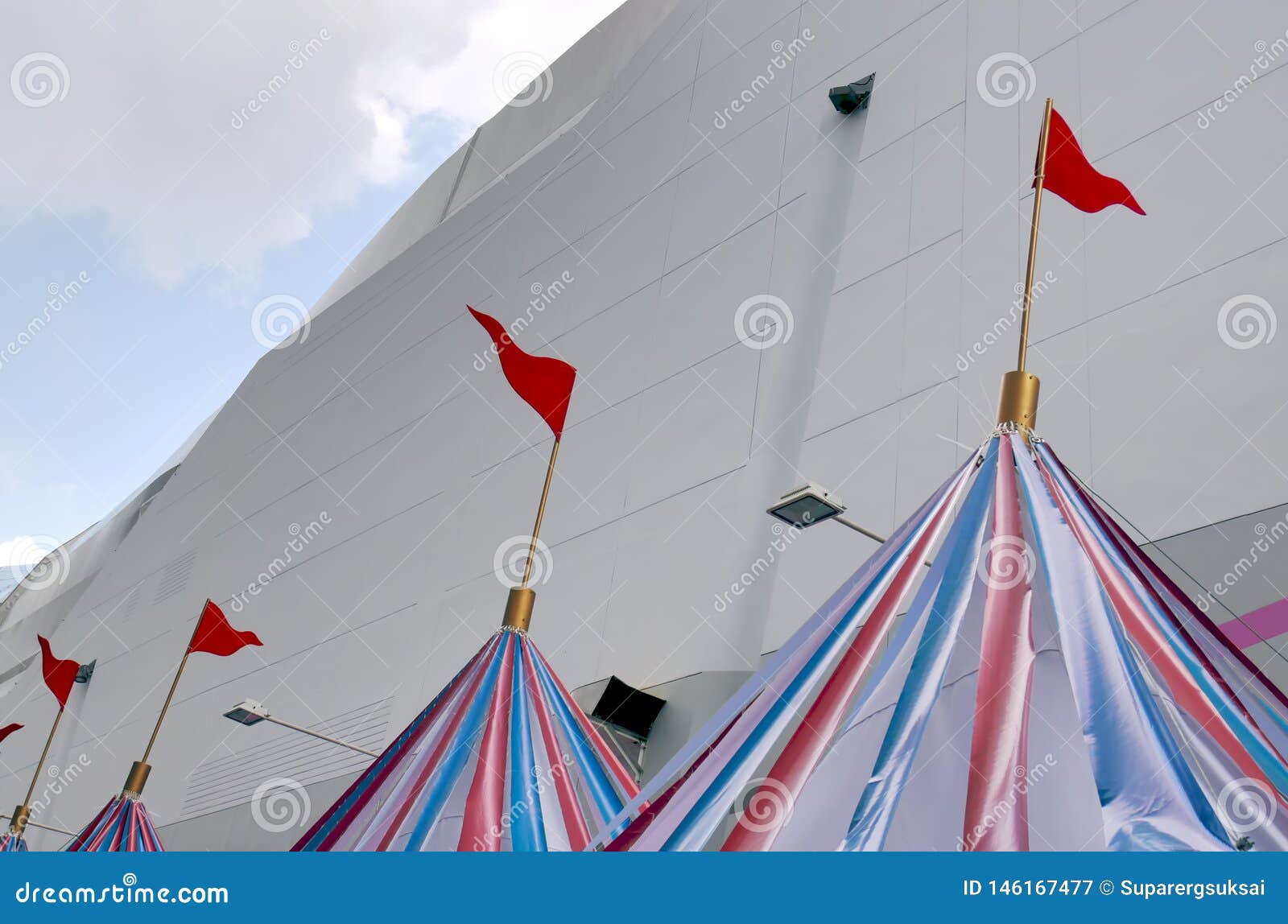 High Section of Colorful Striped Tents with Red Flags at Carnival Stock ...