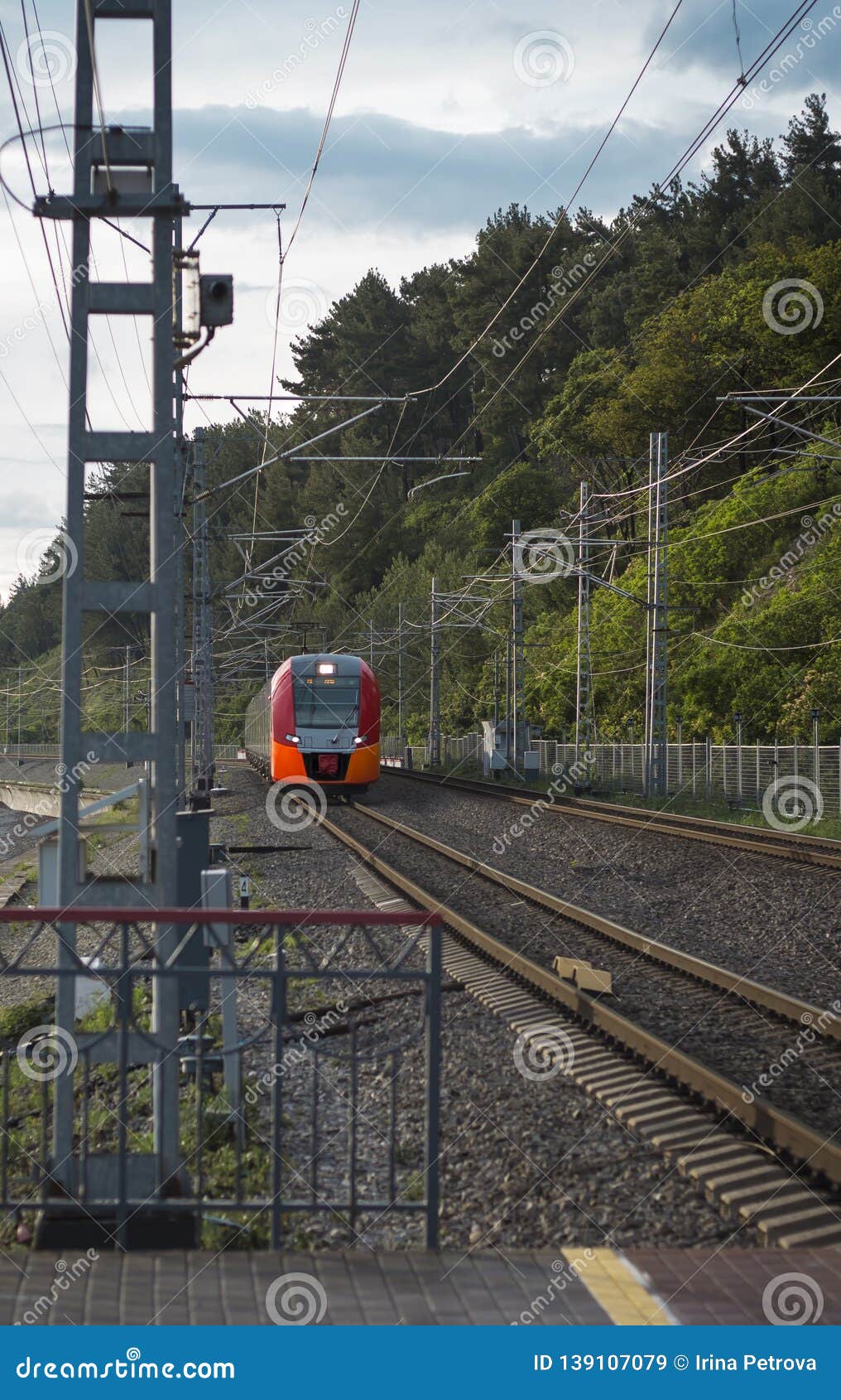 Passenger Train on the Railway Tracks Approaching the Station Stock ...