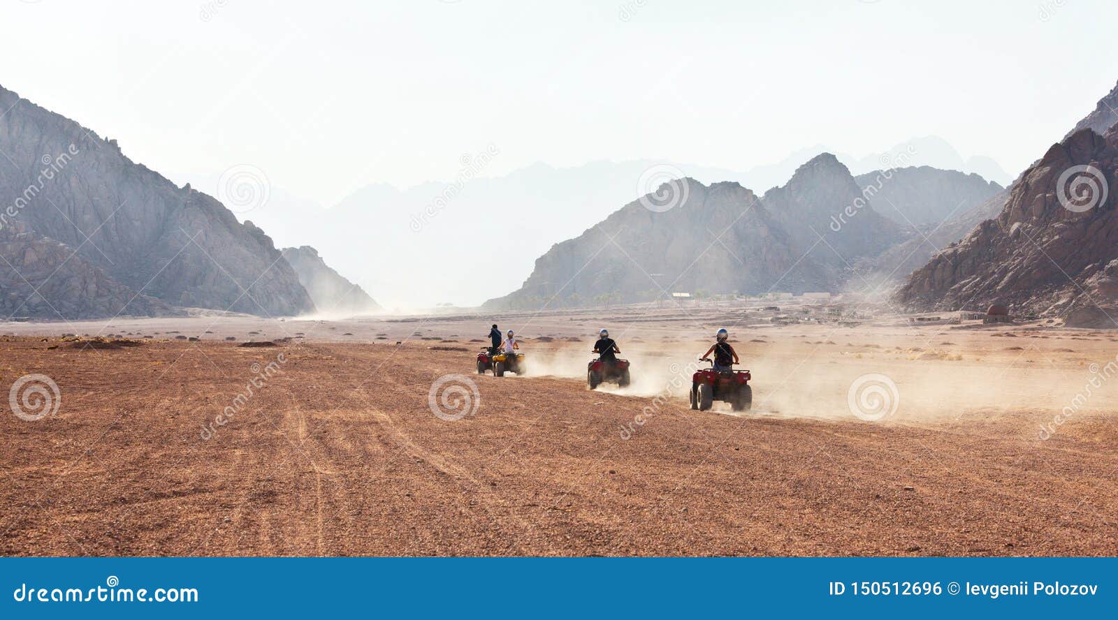 High Speed Race of Several People Riding Quad Bikes in Desert Stock ...
