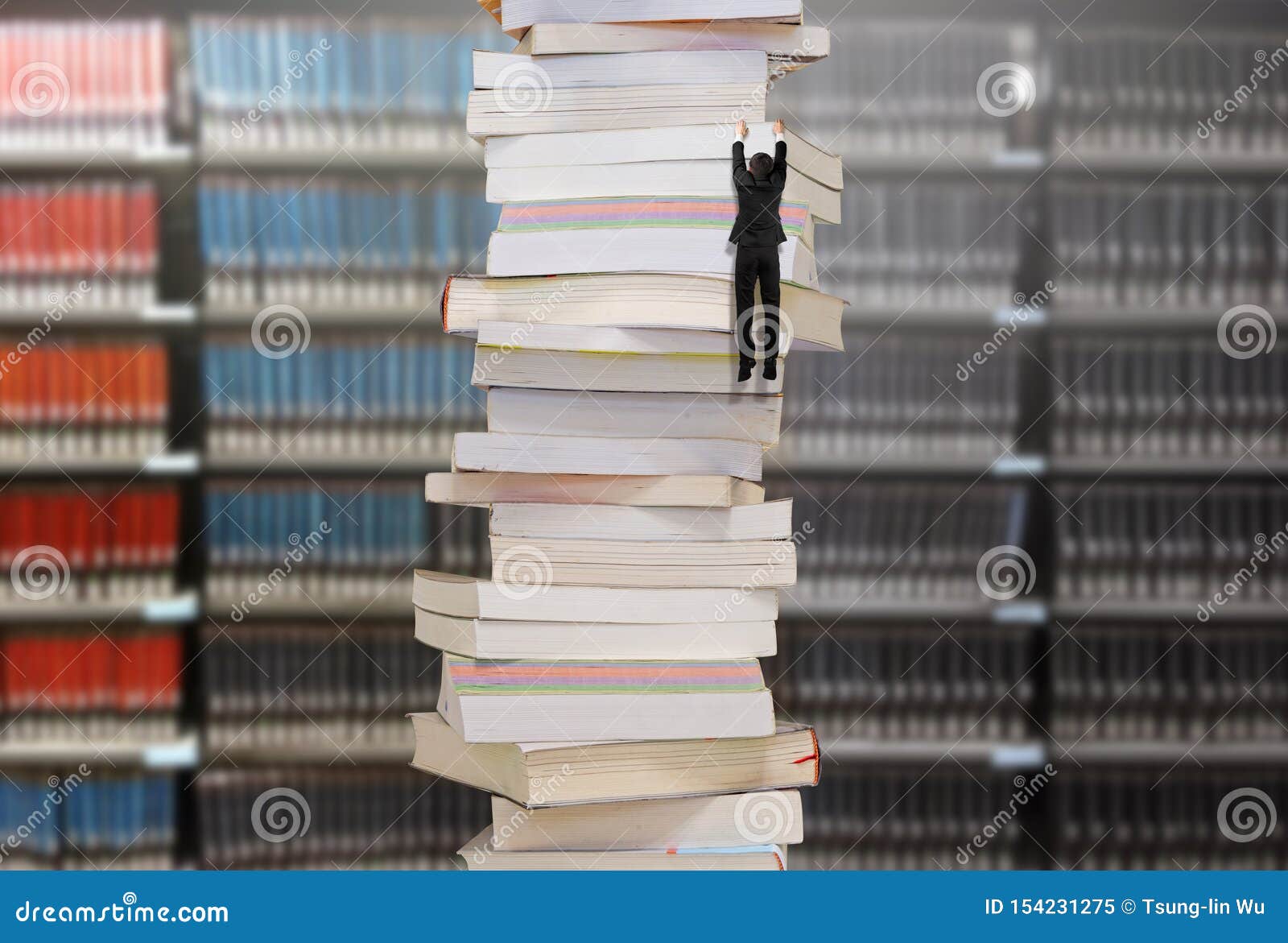 High Stack of Books with Climbing Businessman Hang on it Stock Image ...