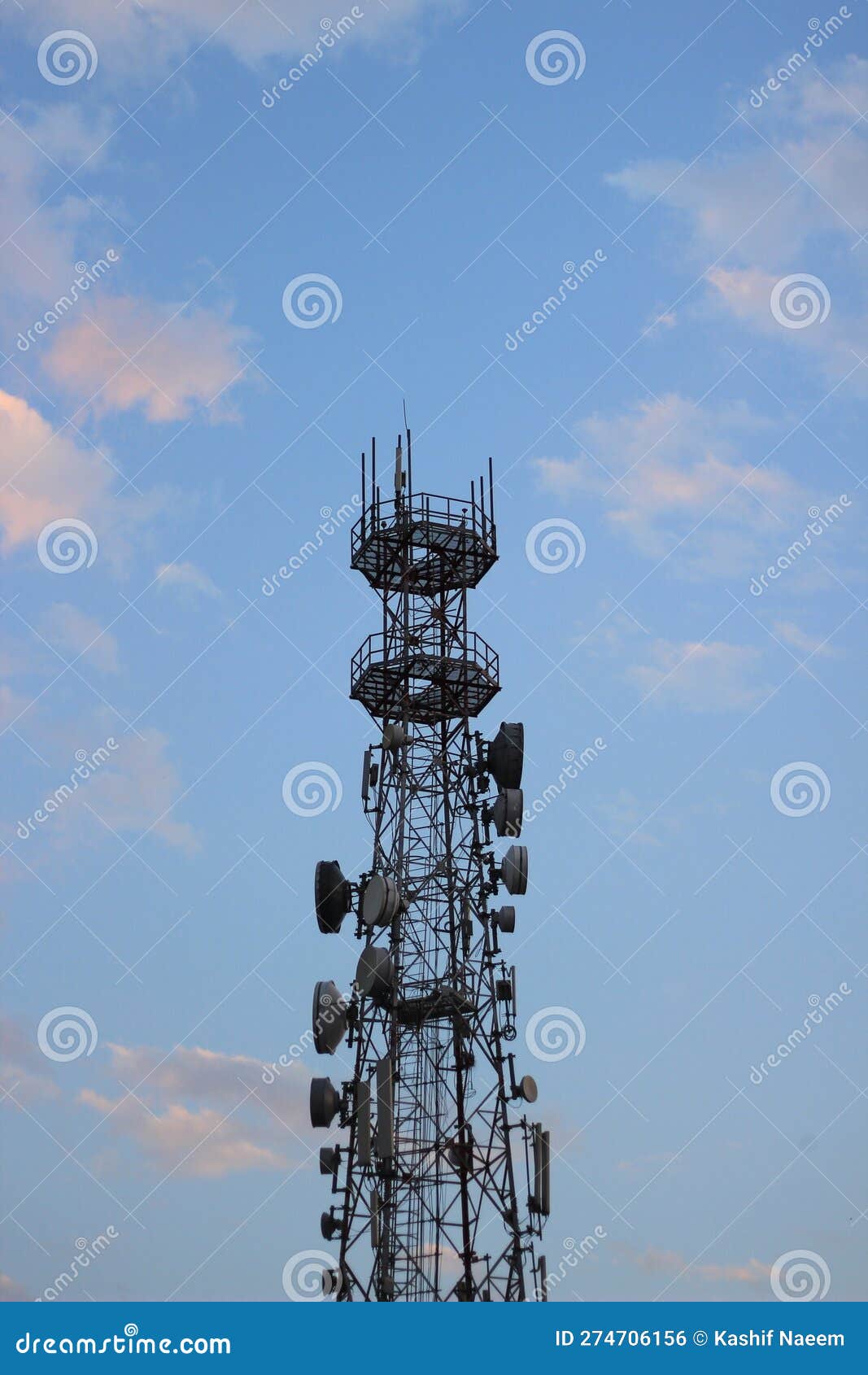 A High Steel Communication Booth Tower with Blue Sky with Scattered ...