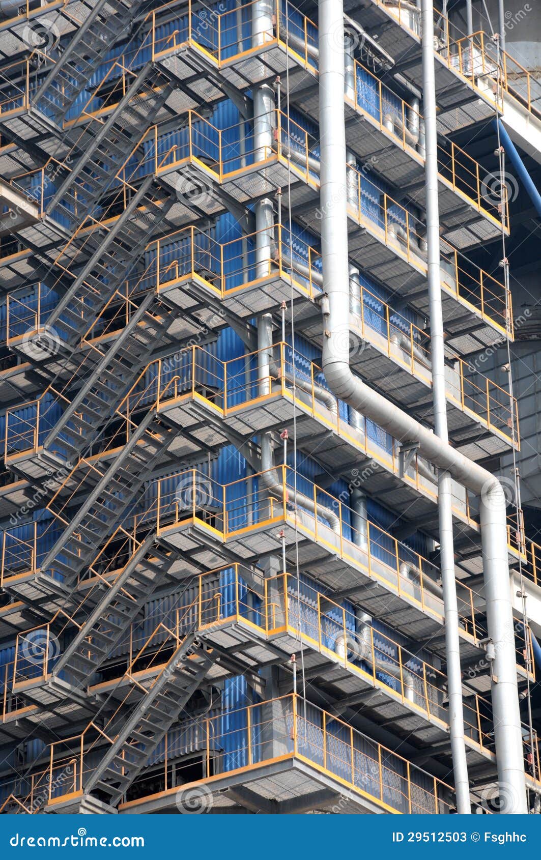 A Group of Yellow Steel Stairs and Pipes on a Tall Stock Image - Image ...